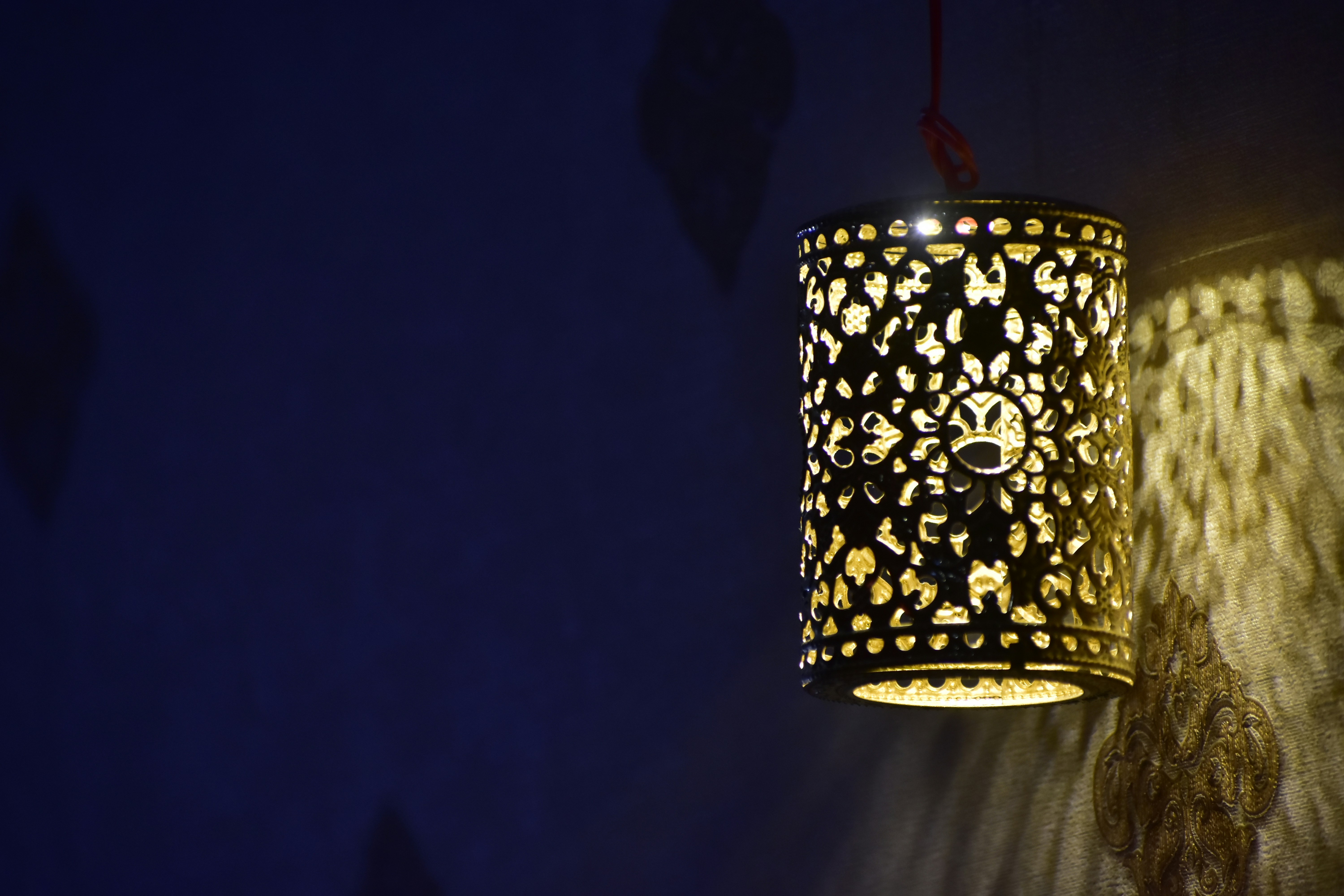 Luminous Filigree: A Hanging Lantern Casting Intricate Shadows