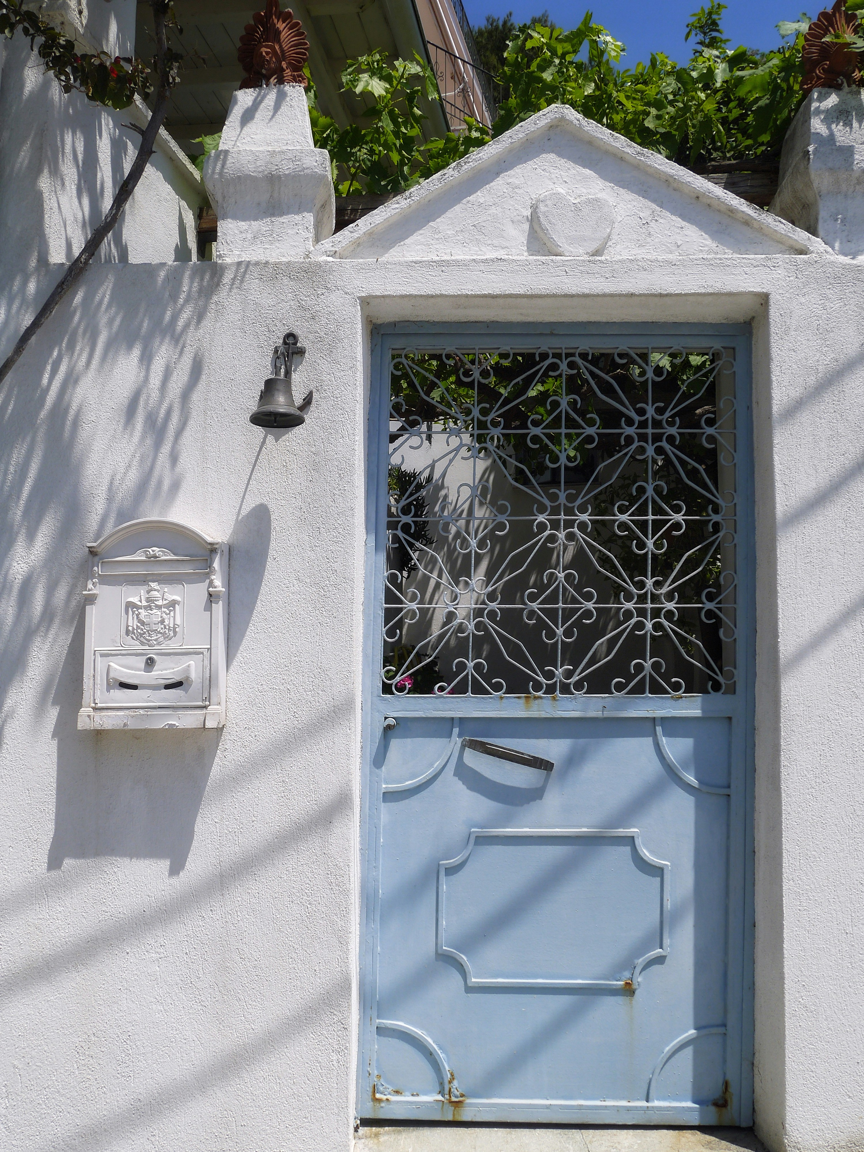 Pastel Gateway: A Mediterranean Door Framed in White Casting
