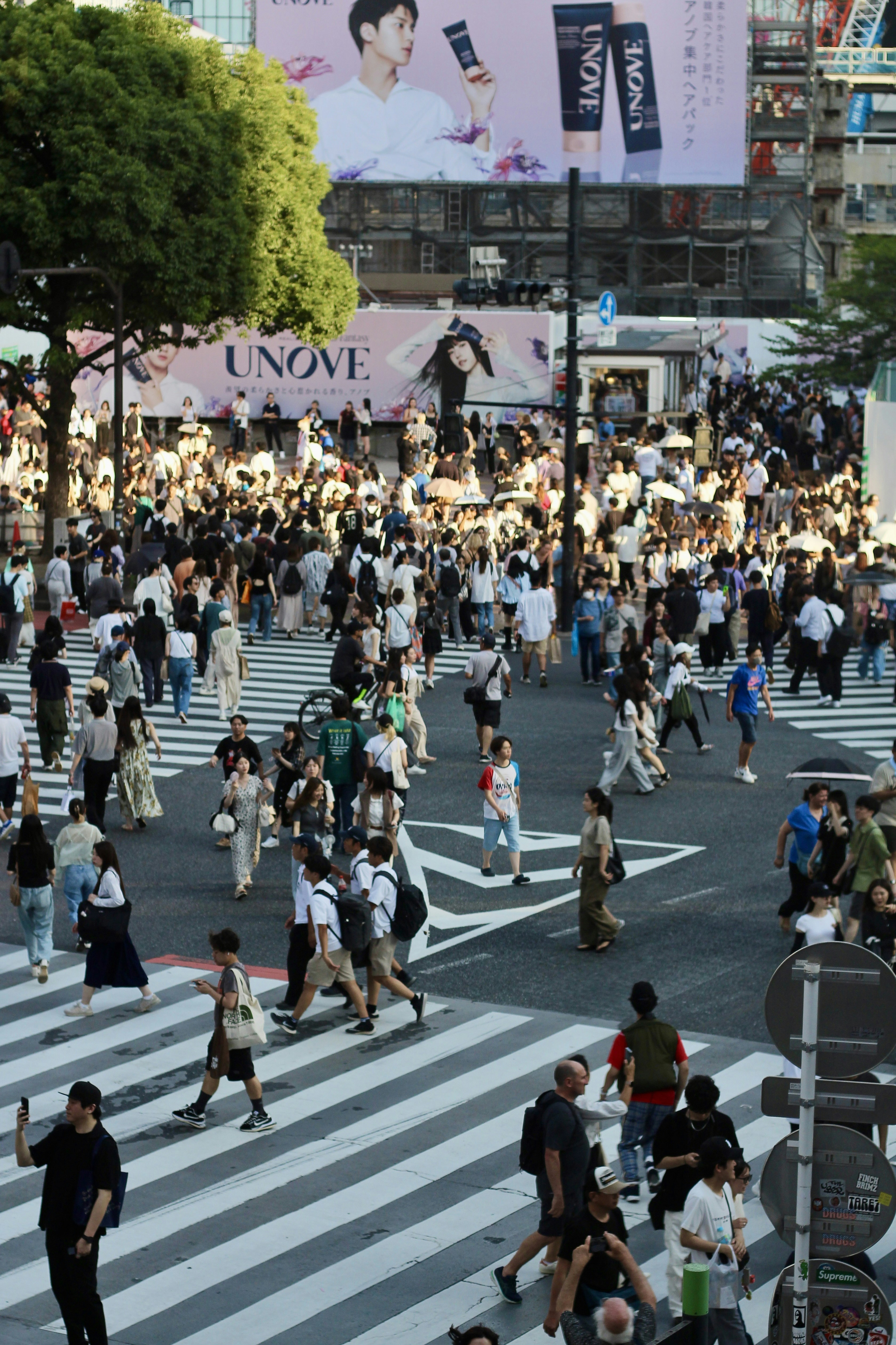 Crowd Crossing at a Bright City Crosswalk With Event Banners