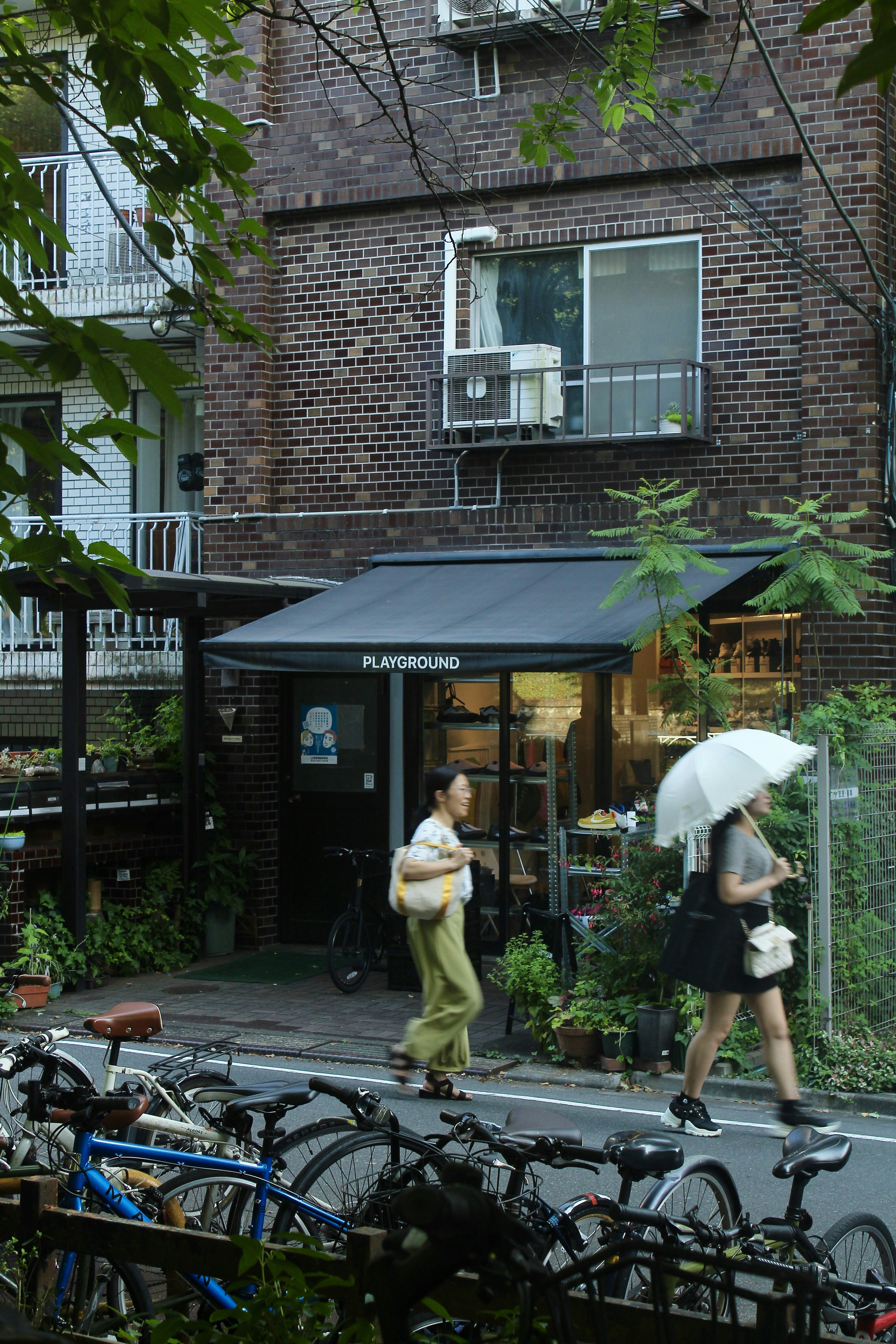 Cafe on the Corner: Quiet Pedestrians Through a Brick Terrace