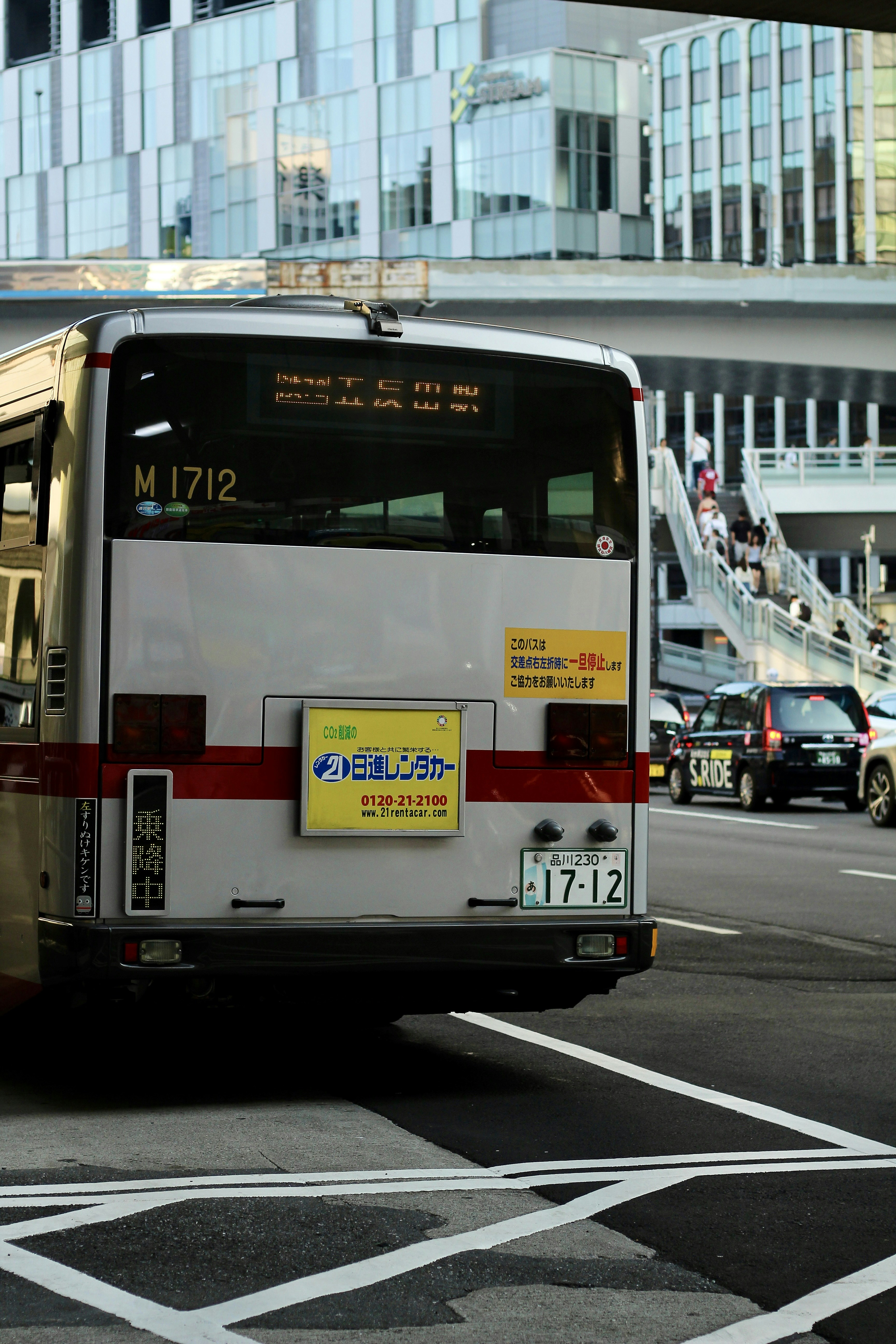 Rear View of a City Bus against a Modern Glass Facade
