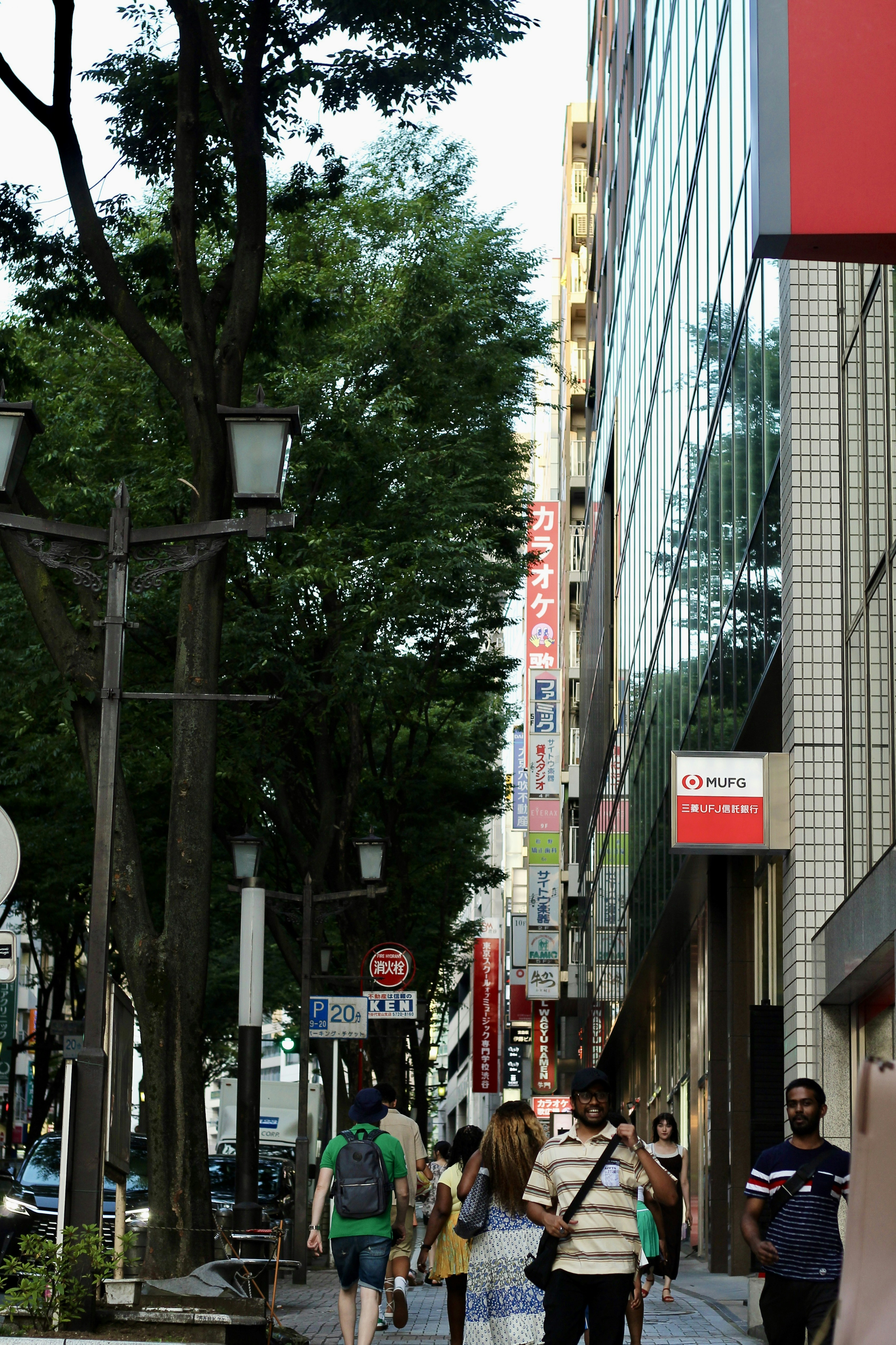 Urban Pulse: Pedestrians Make Their Way Through a Neon-Trimmed Street