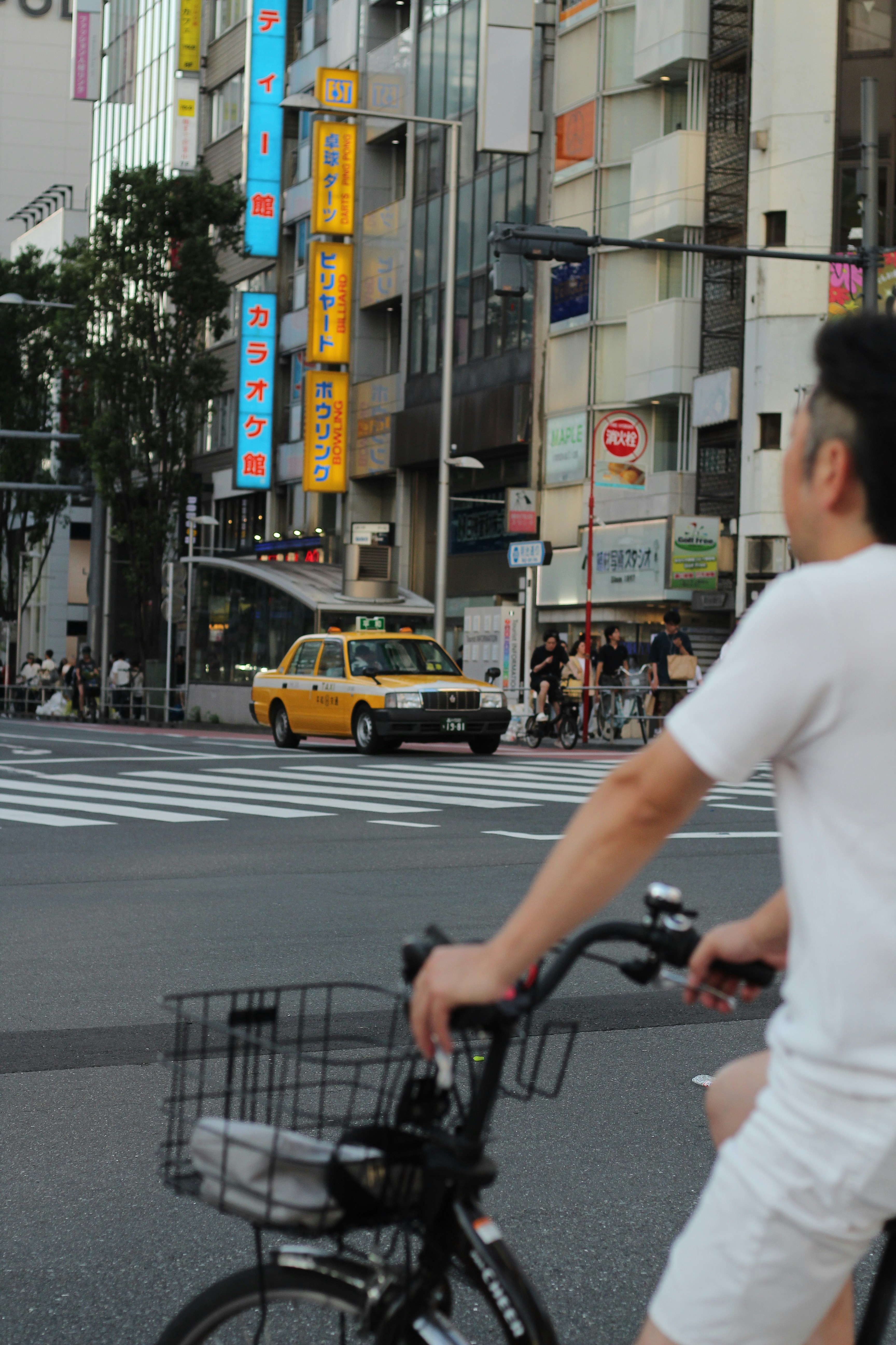 Urban Citadel: A Yellow Taxi Crosses a Pedestrian Crossing Framed by City High-Rines