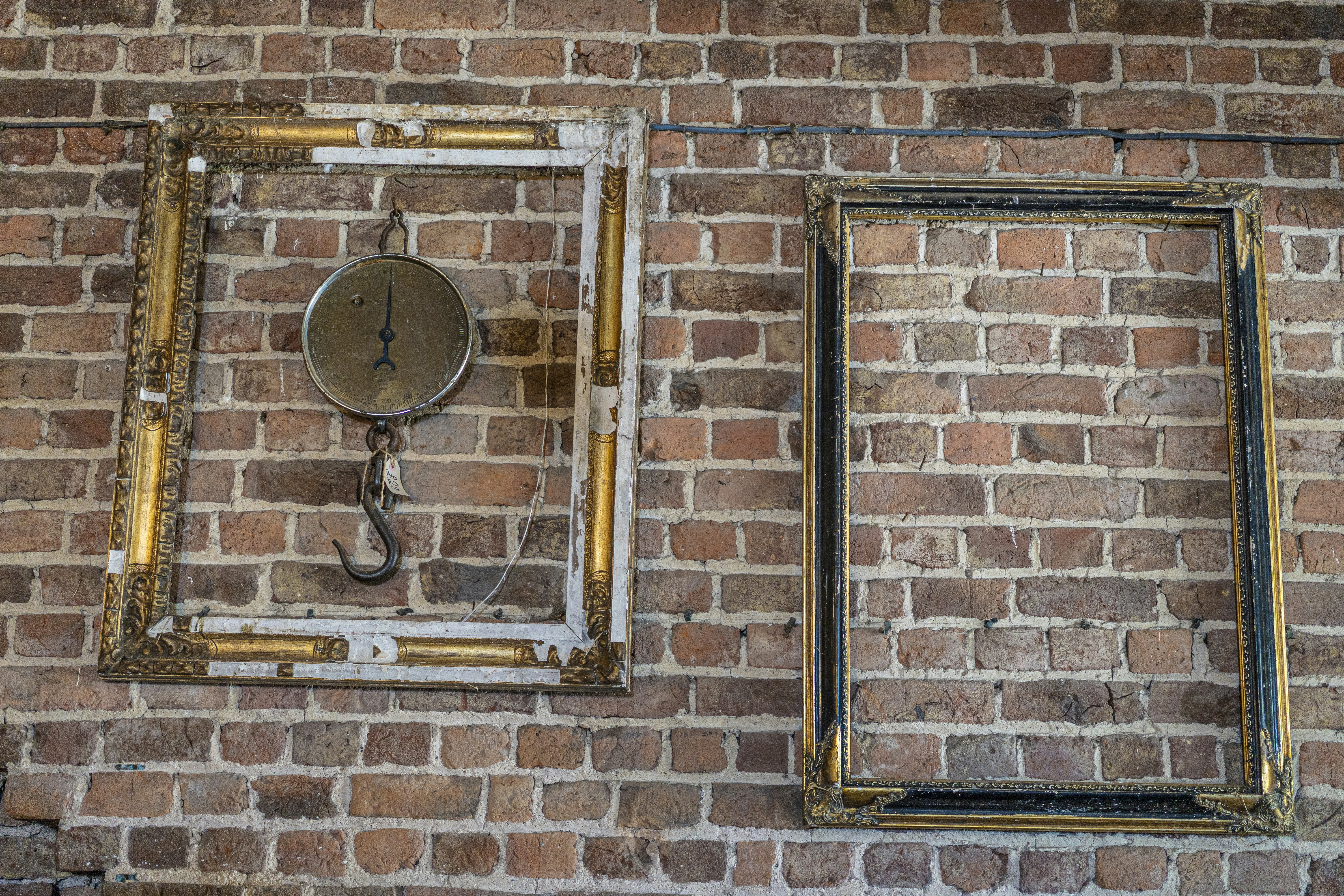 Frame Within a Frame: Rustic Clock and Empty Gallery on a Brick Wall