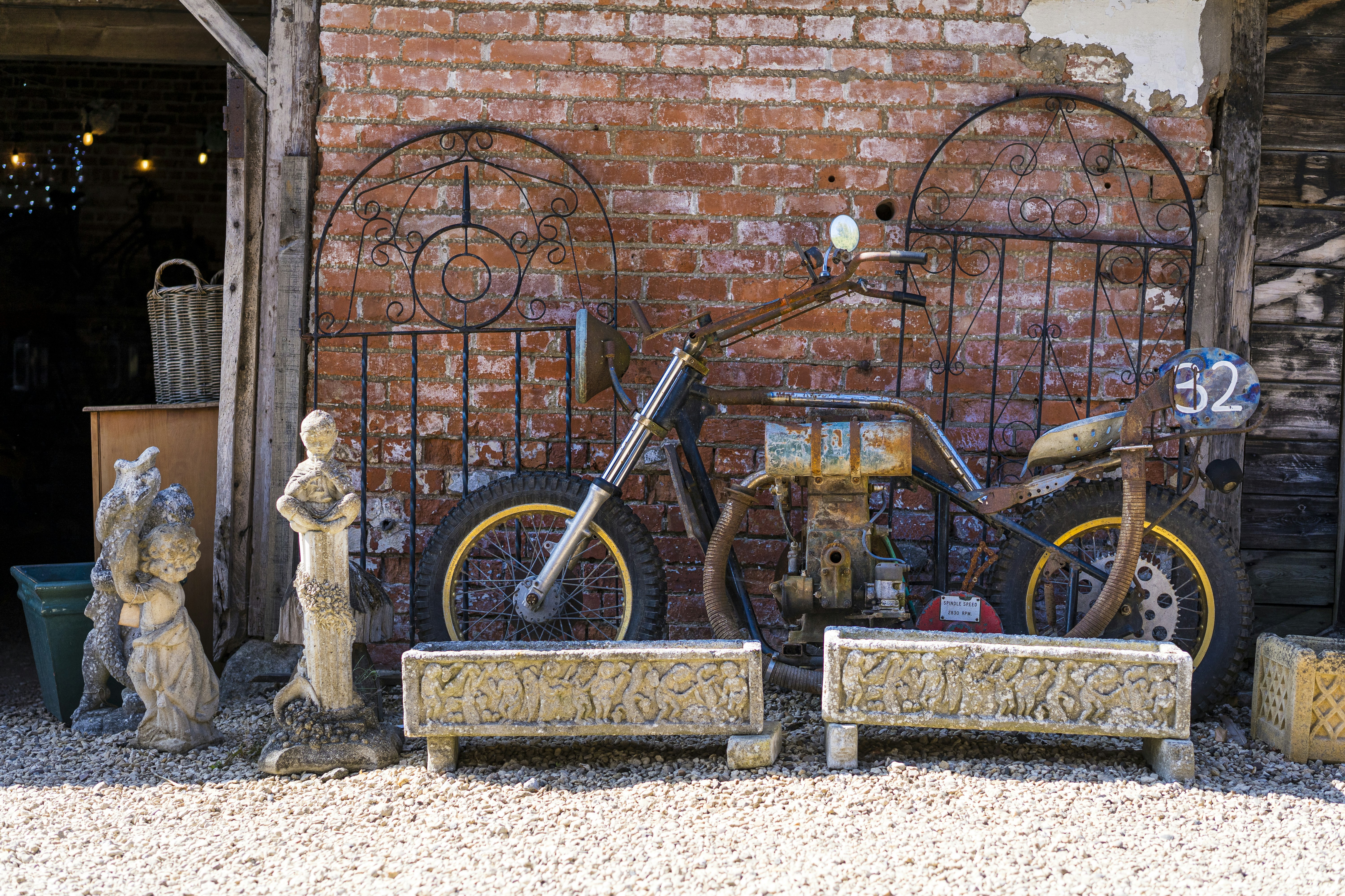 Vintage Motorcycle and Ornamental Old World Garden