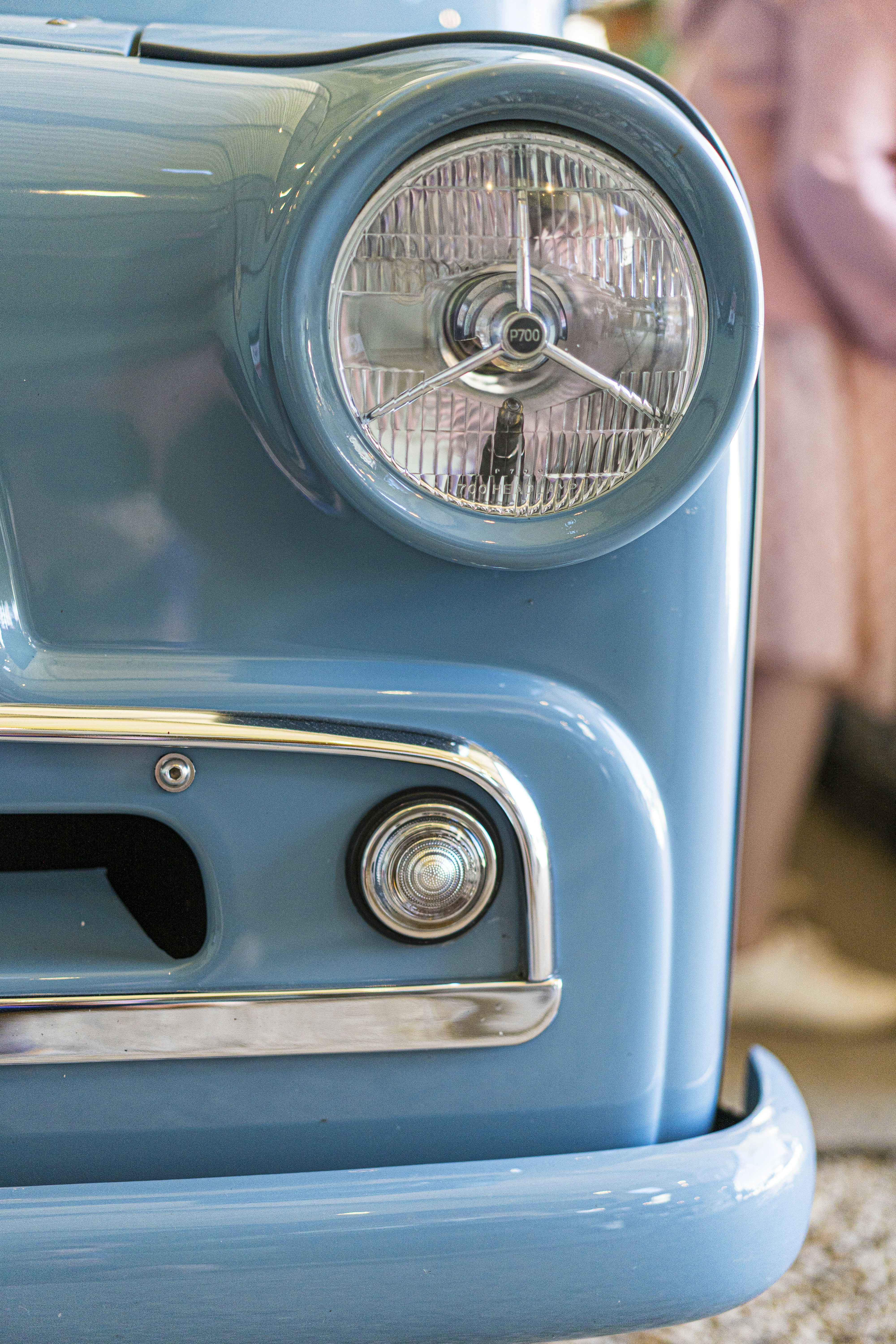 Blue Vintage Headlight Portrait: A Classic Car’s Steel Face