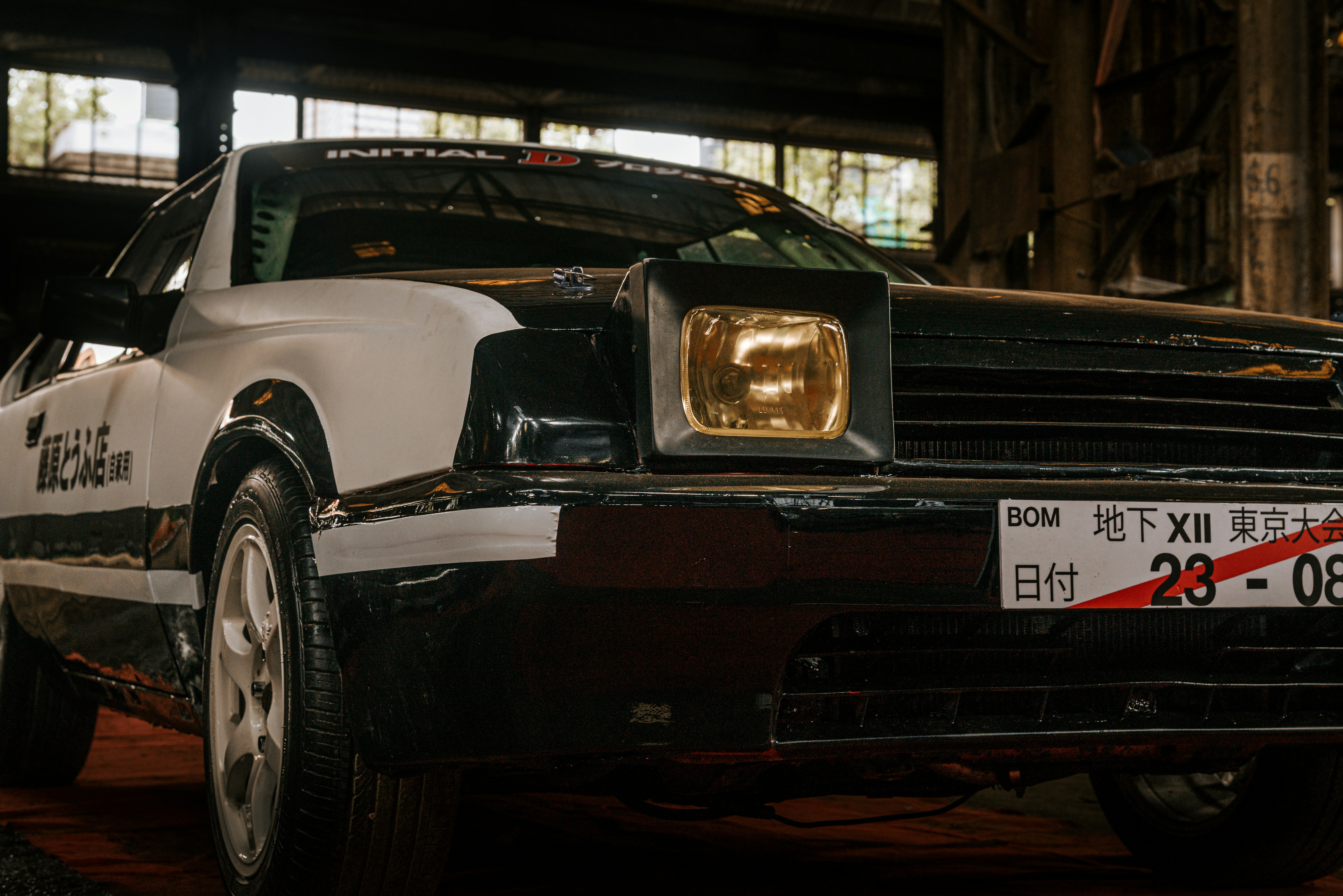Underneath the Grille: A Classic Car in Dim Hangar Light
