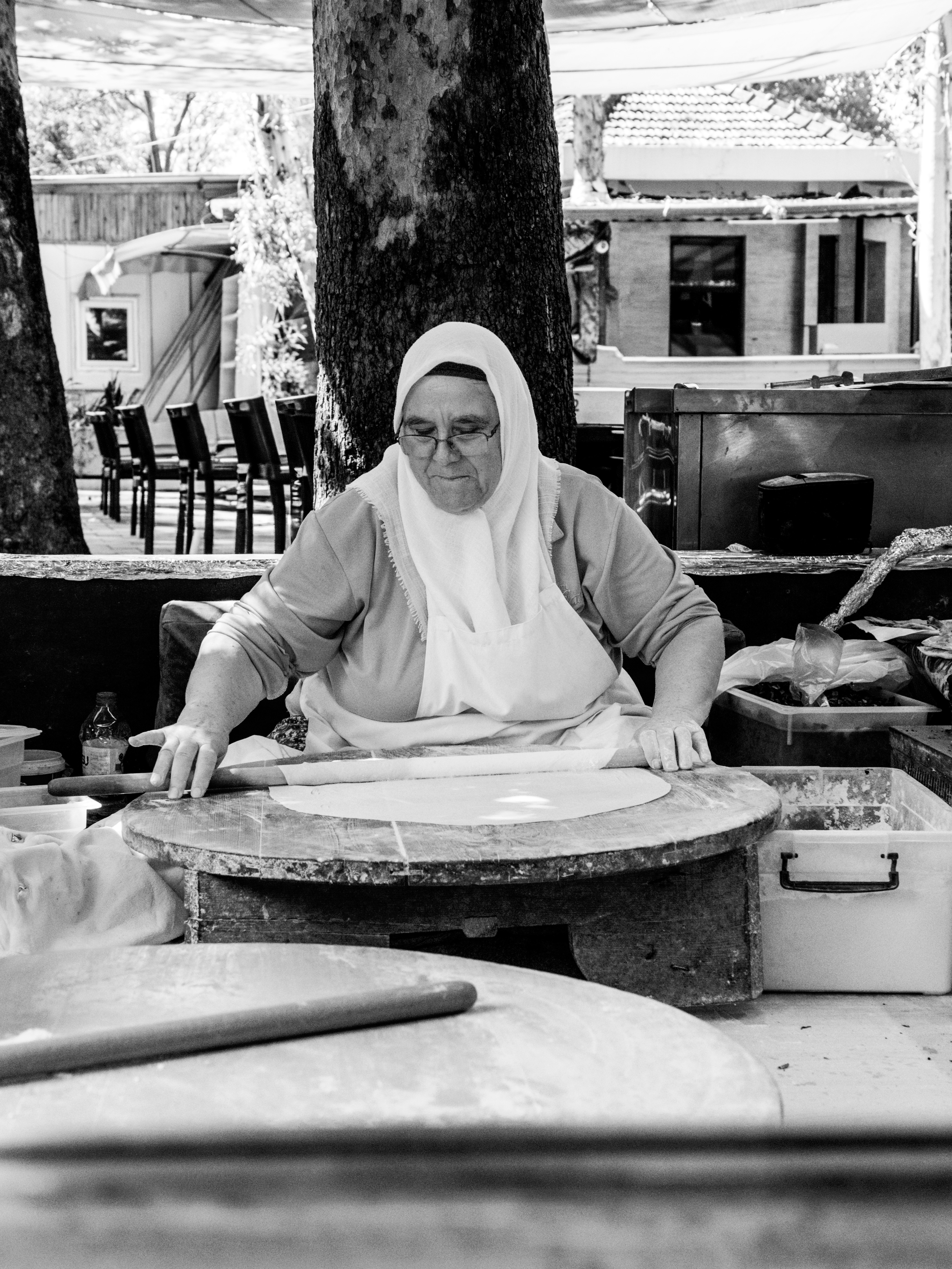 The Dough Precision: An Elderly Baker Sculpting Bread Beneath a Quiet Tree