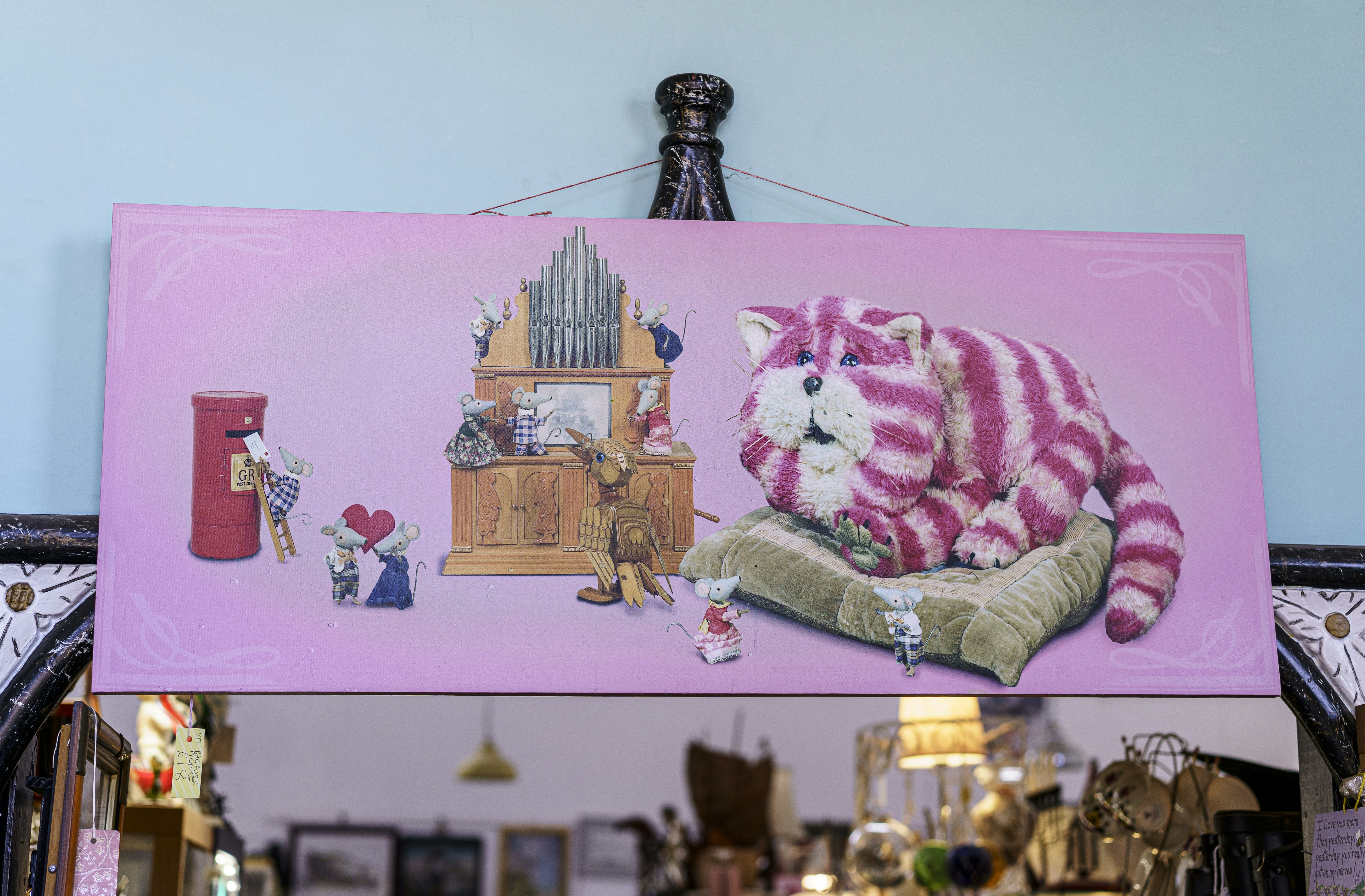 Pink Cat Billboard Above a Shop Entrance