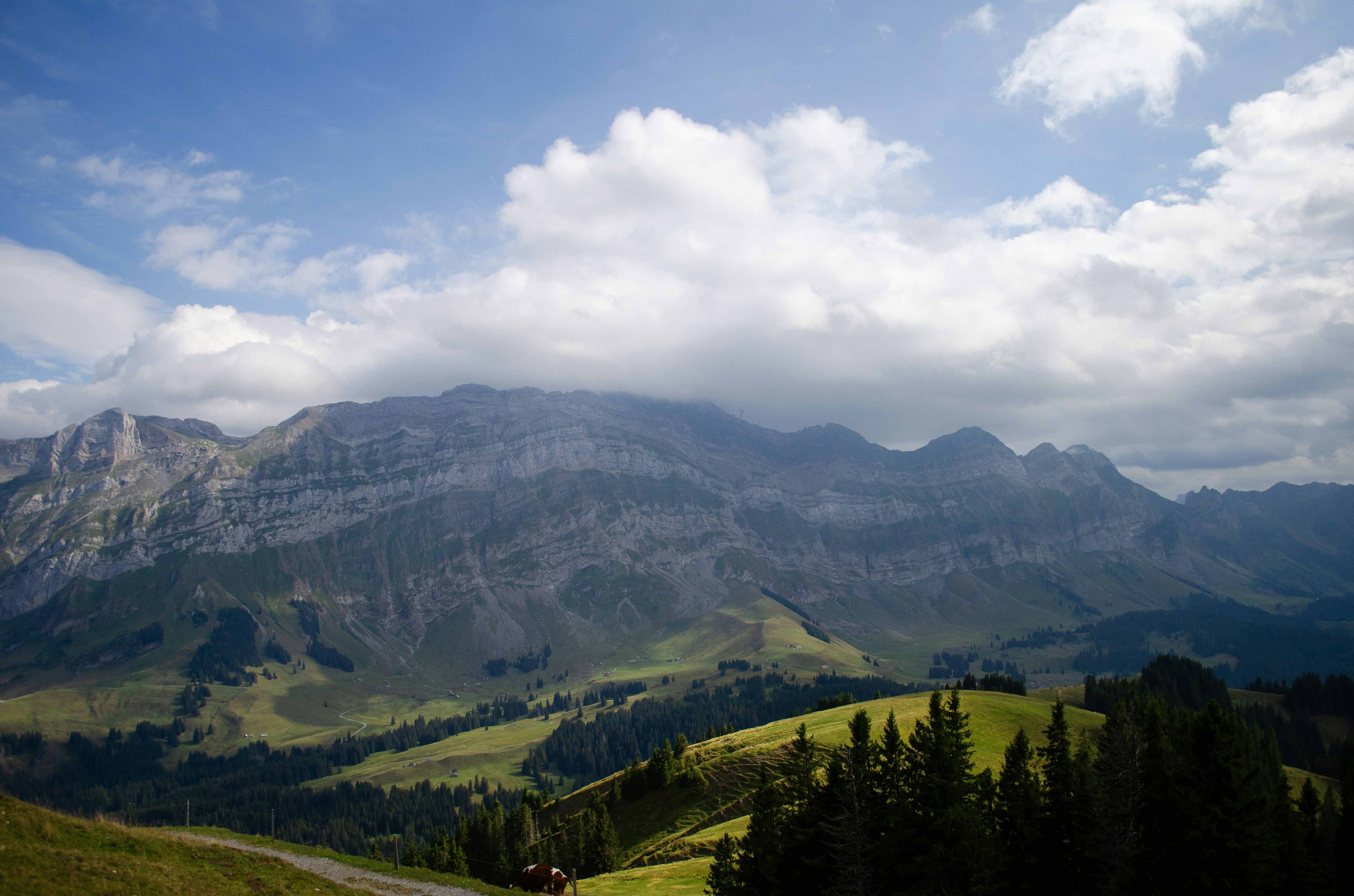 Clouds Over the Valley: A Mountain Pass Beneath the Crest
