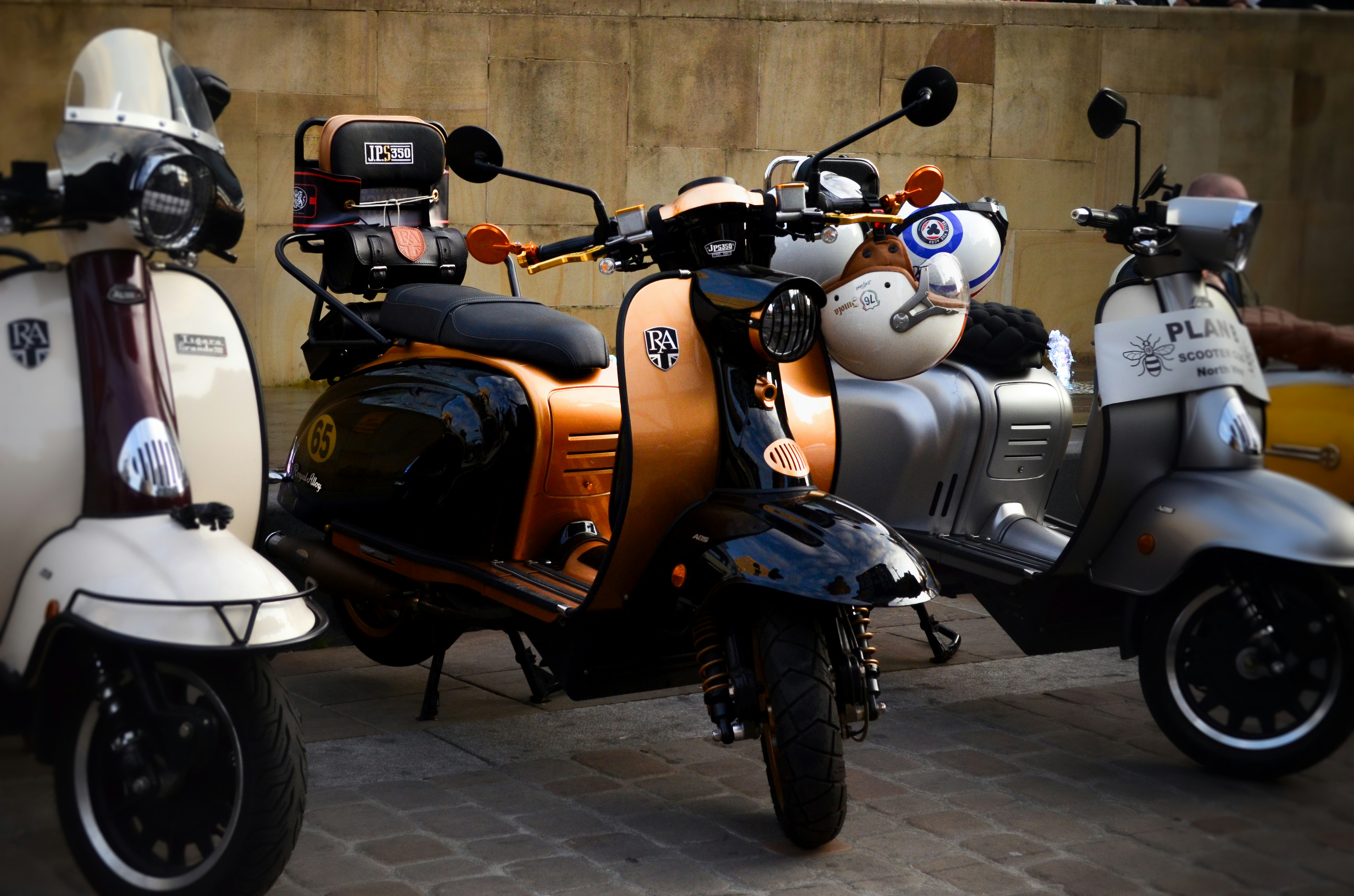 Orange Vintage Scooter Centerstage: A Row of Retro Rides in a Quiet Piazza