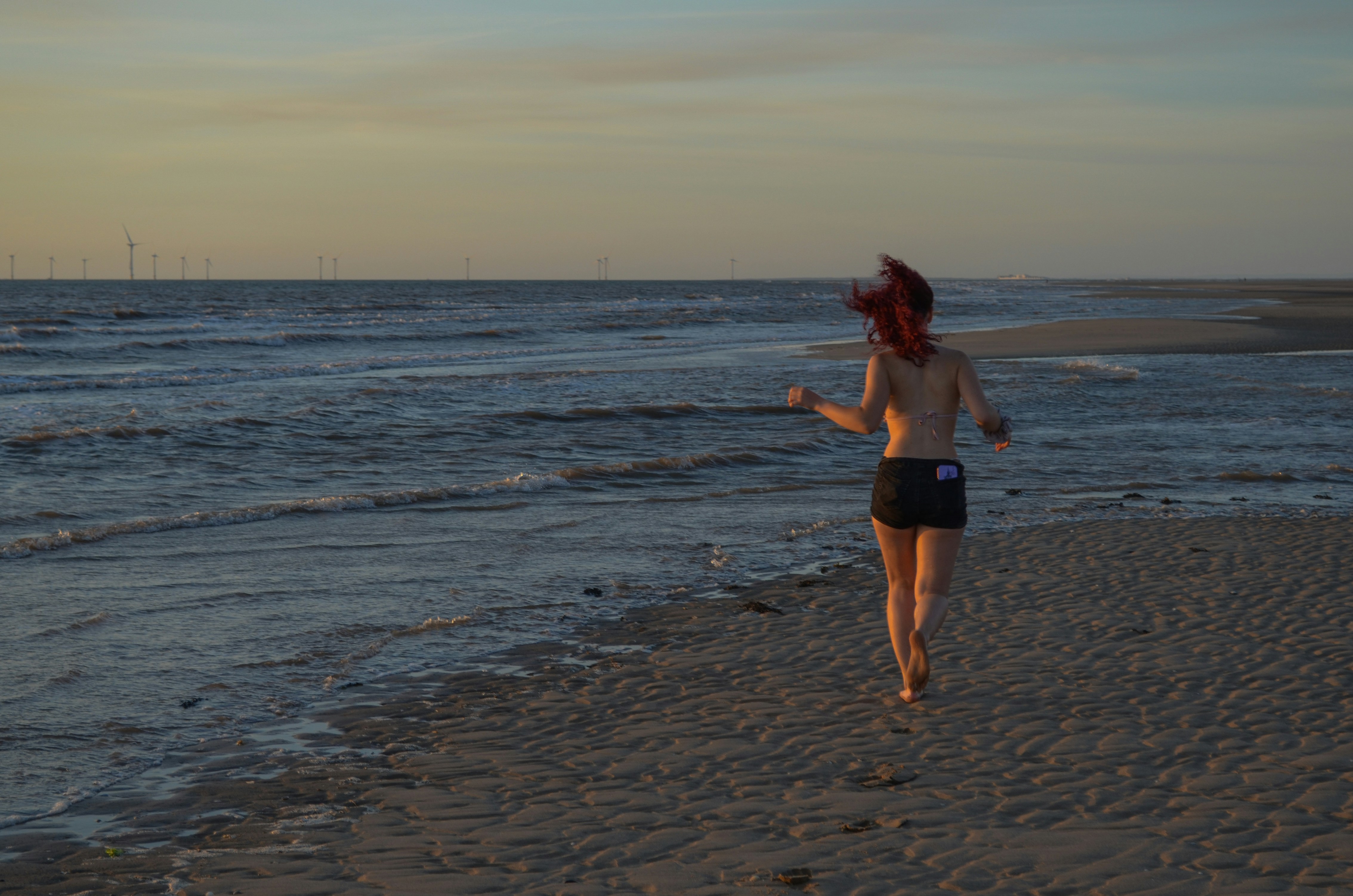 Solo Runner on a Quiet Seashore at Dusk