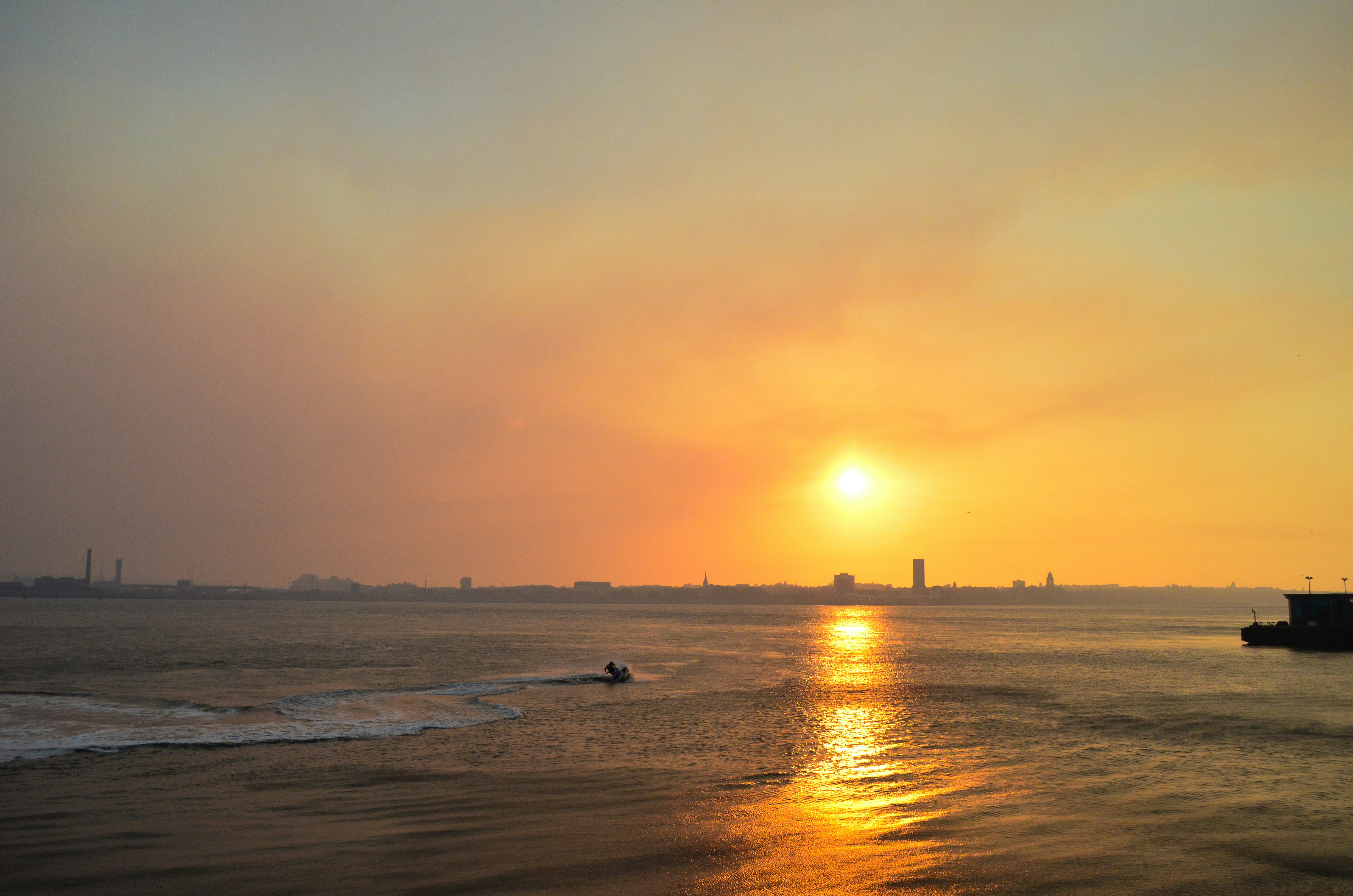 Golden Harbor: Sunset Over Quiet Waves