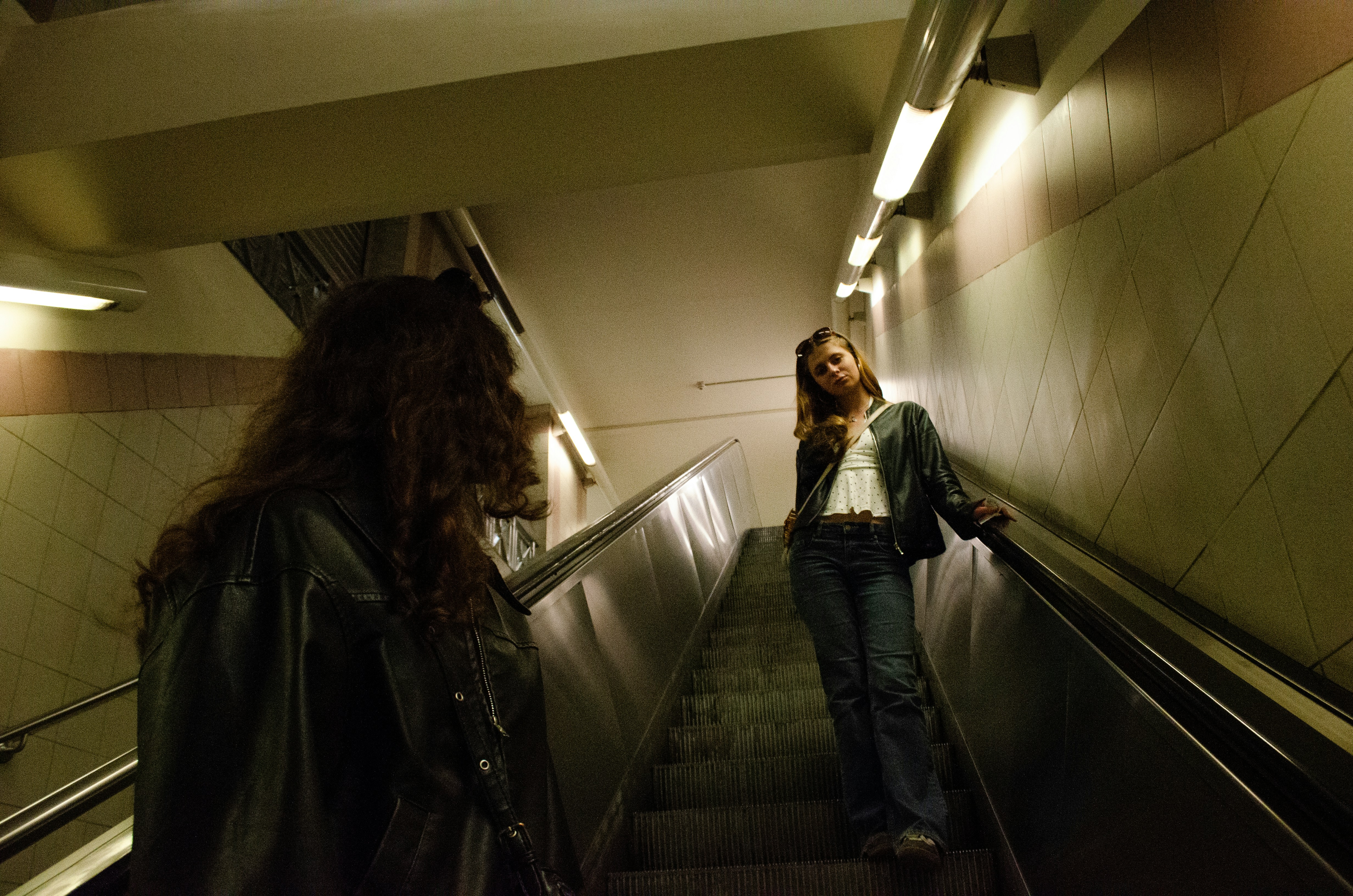 Tilted Gaze on the Escalator: A Portrait in the Subway Light