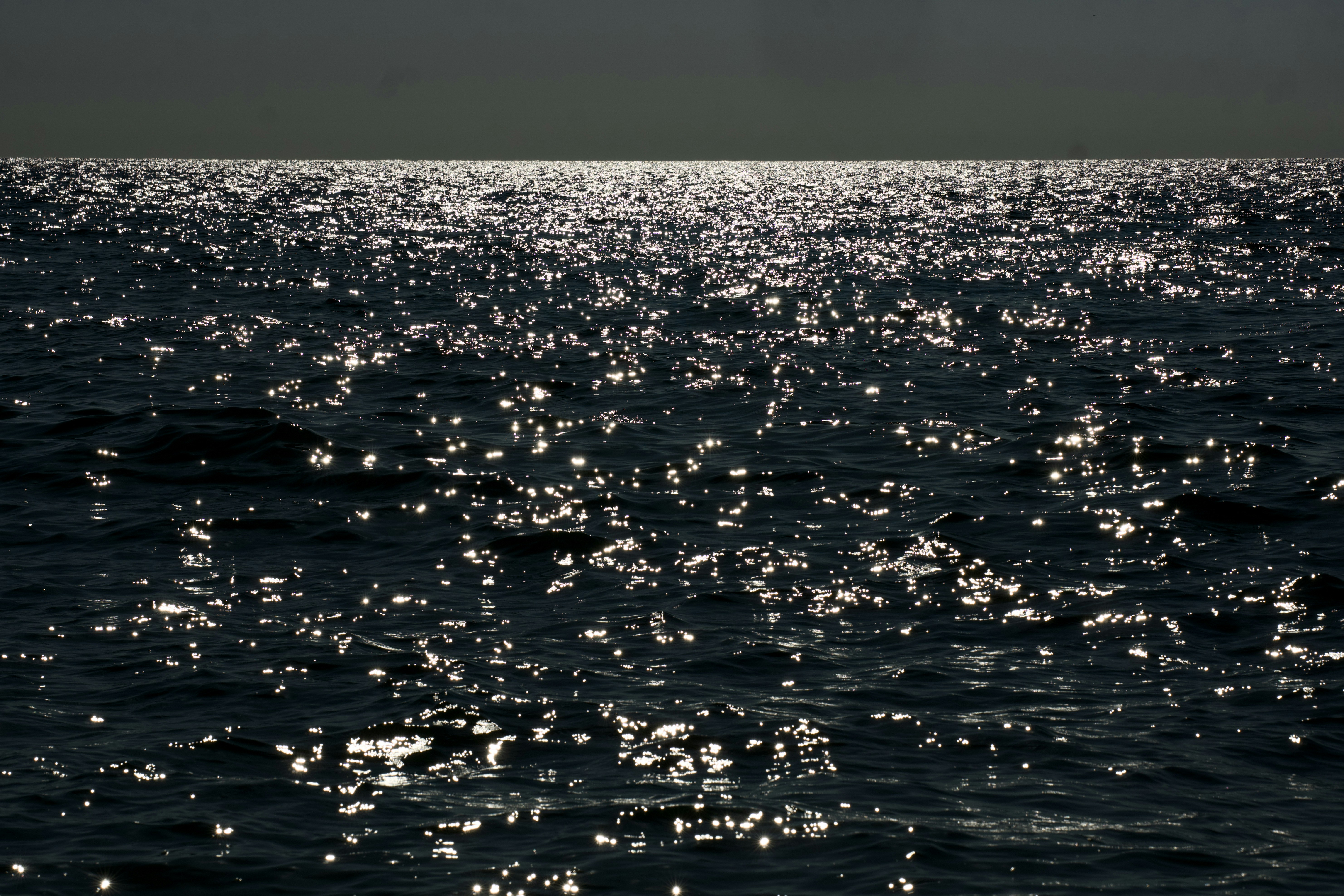 Gleam on the Ocean: Sunlit Ripples Across a Quiet Sea