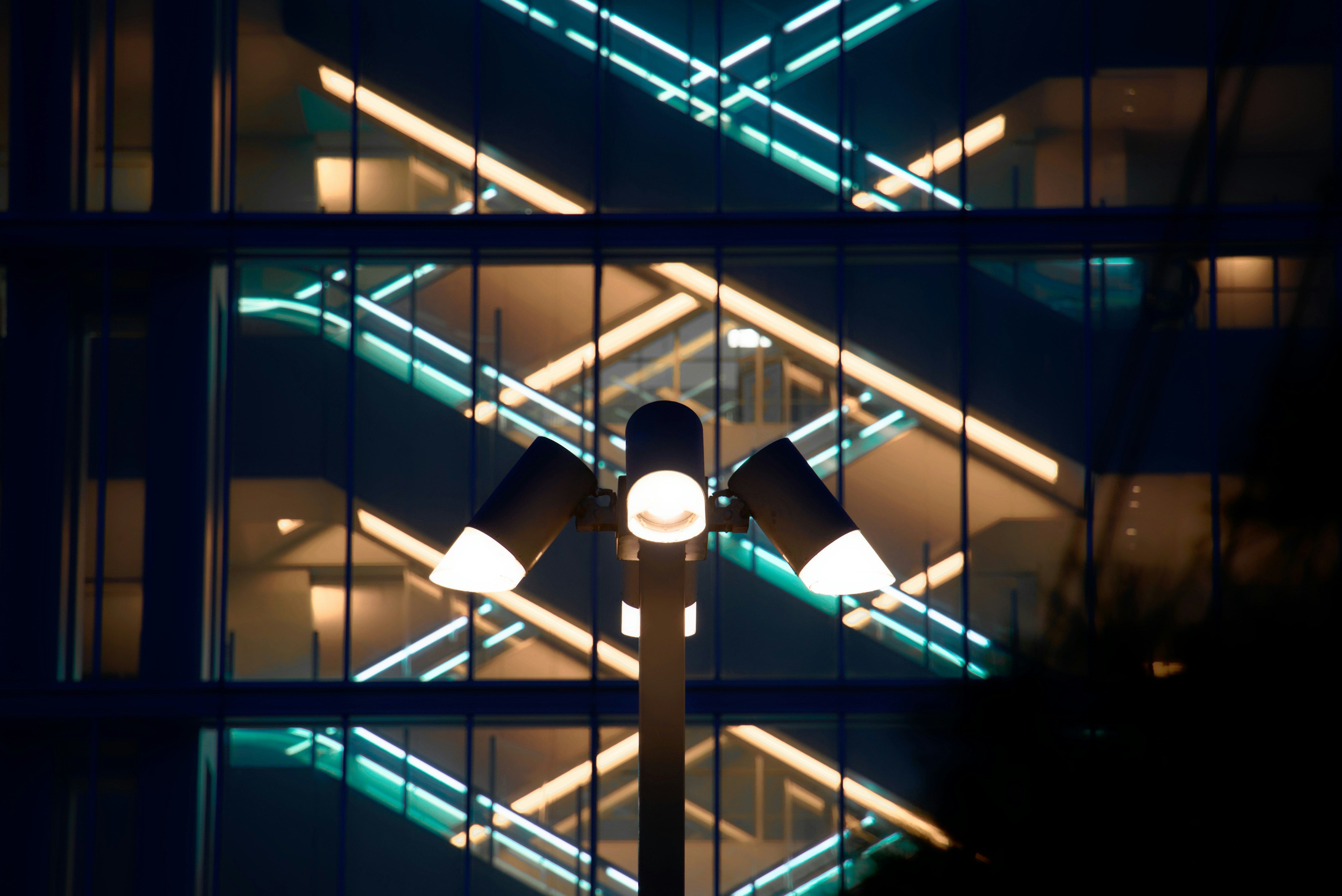 Neon Lattice Glow Behind a Silent Lamppost
