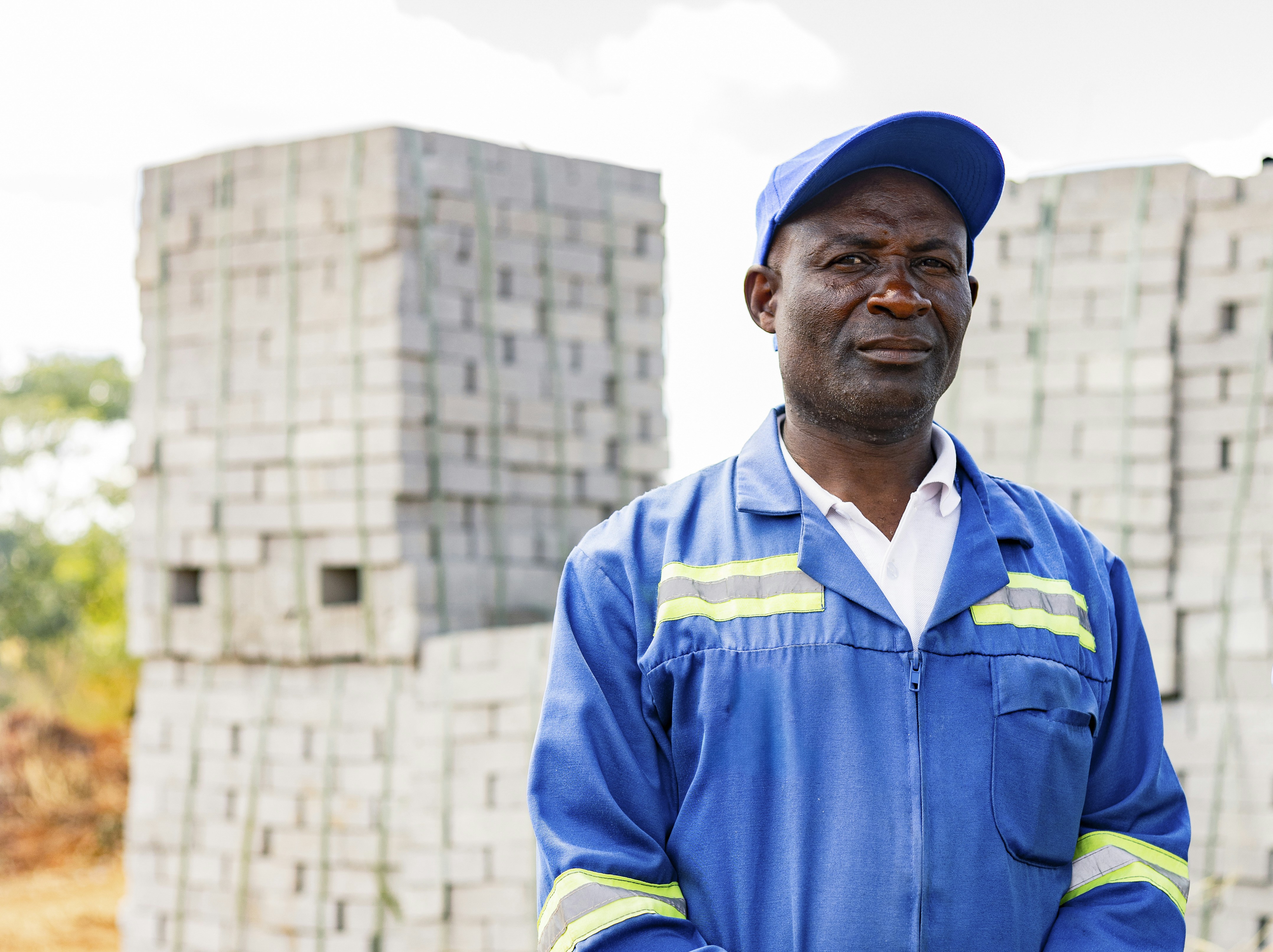 Blue-Covered Foreman Amidst Brick Piles