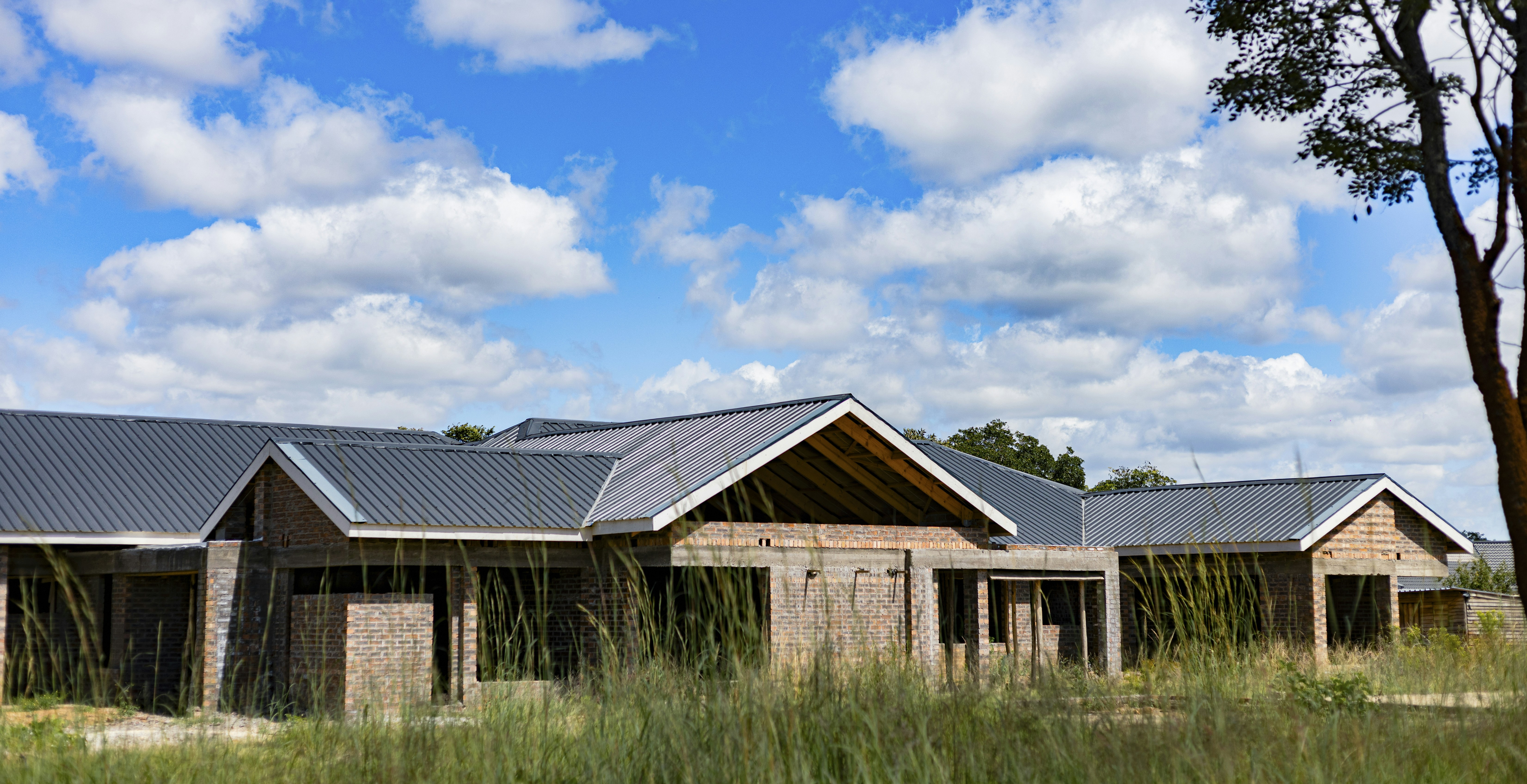 Deserted Charm: Modern Brick Homes under a Wide Blue Sky