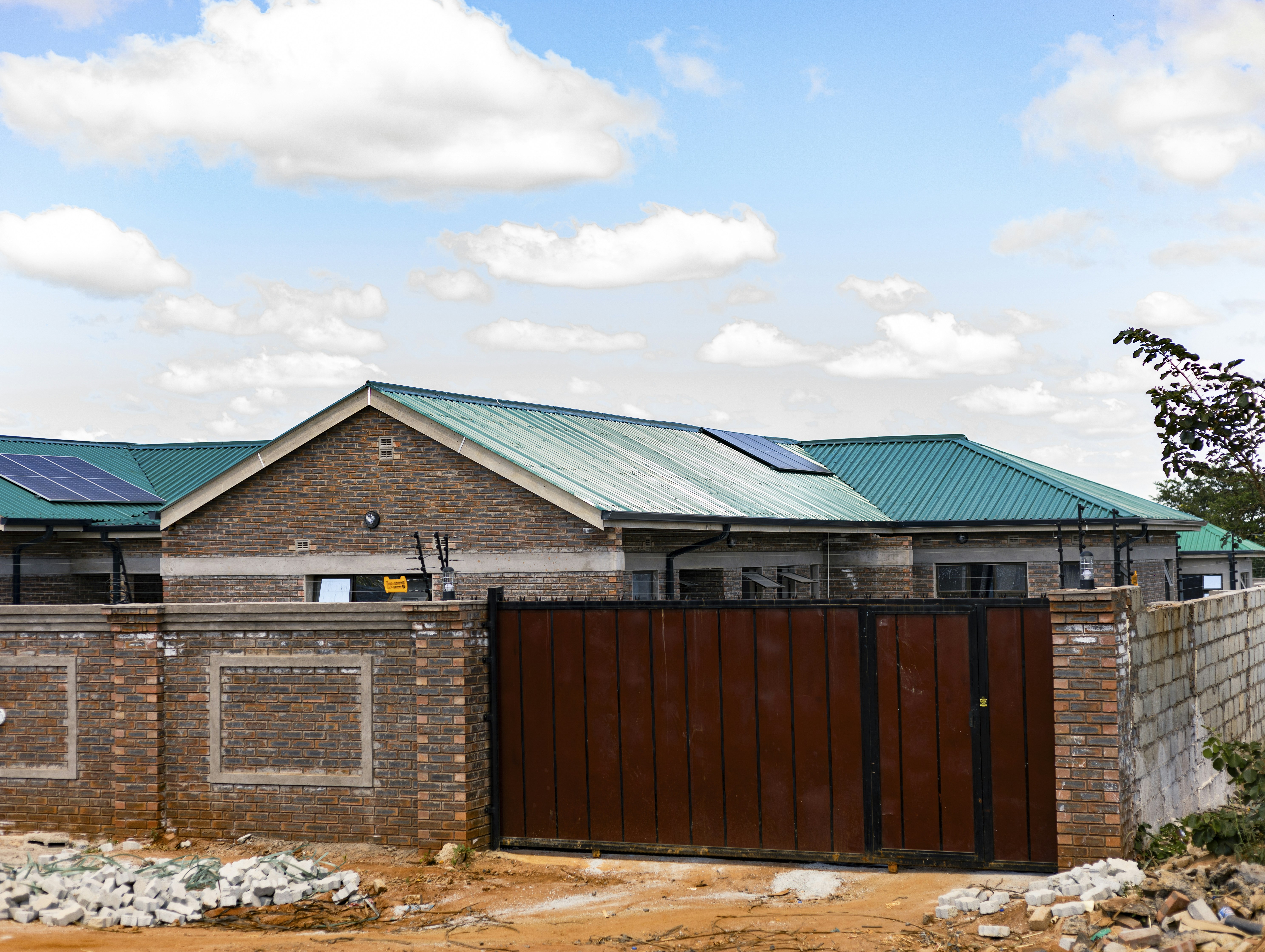 Locked Gates and Green Roofs: A Quiet Boundary Between Brick and Sky