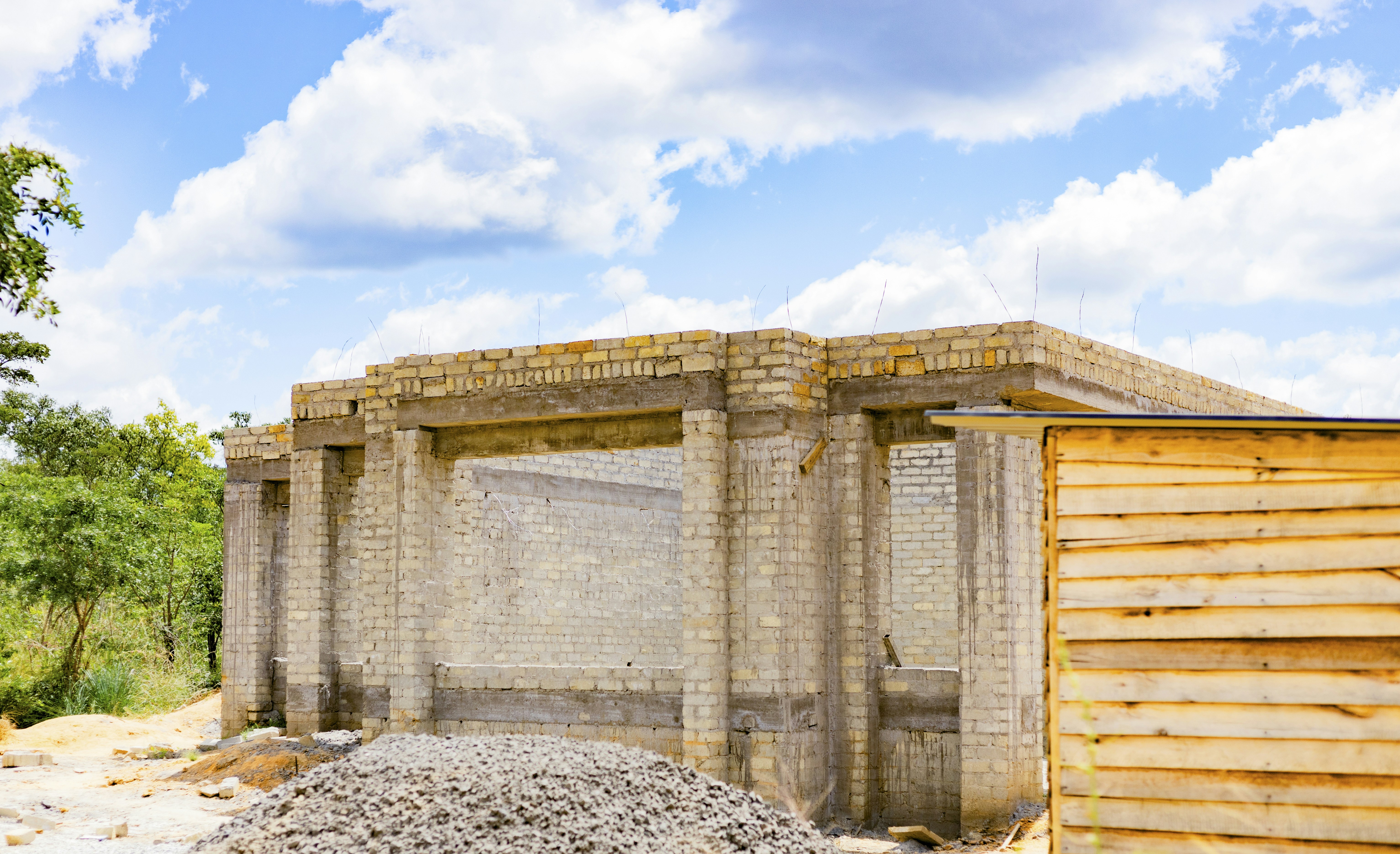 Under Construction: Brick Archway Framed by Wooden Shed