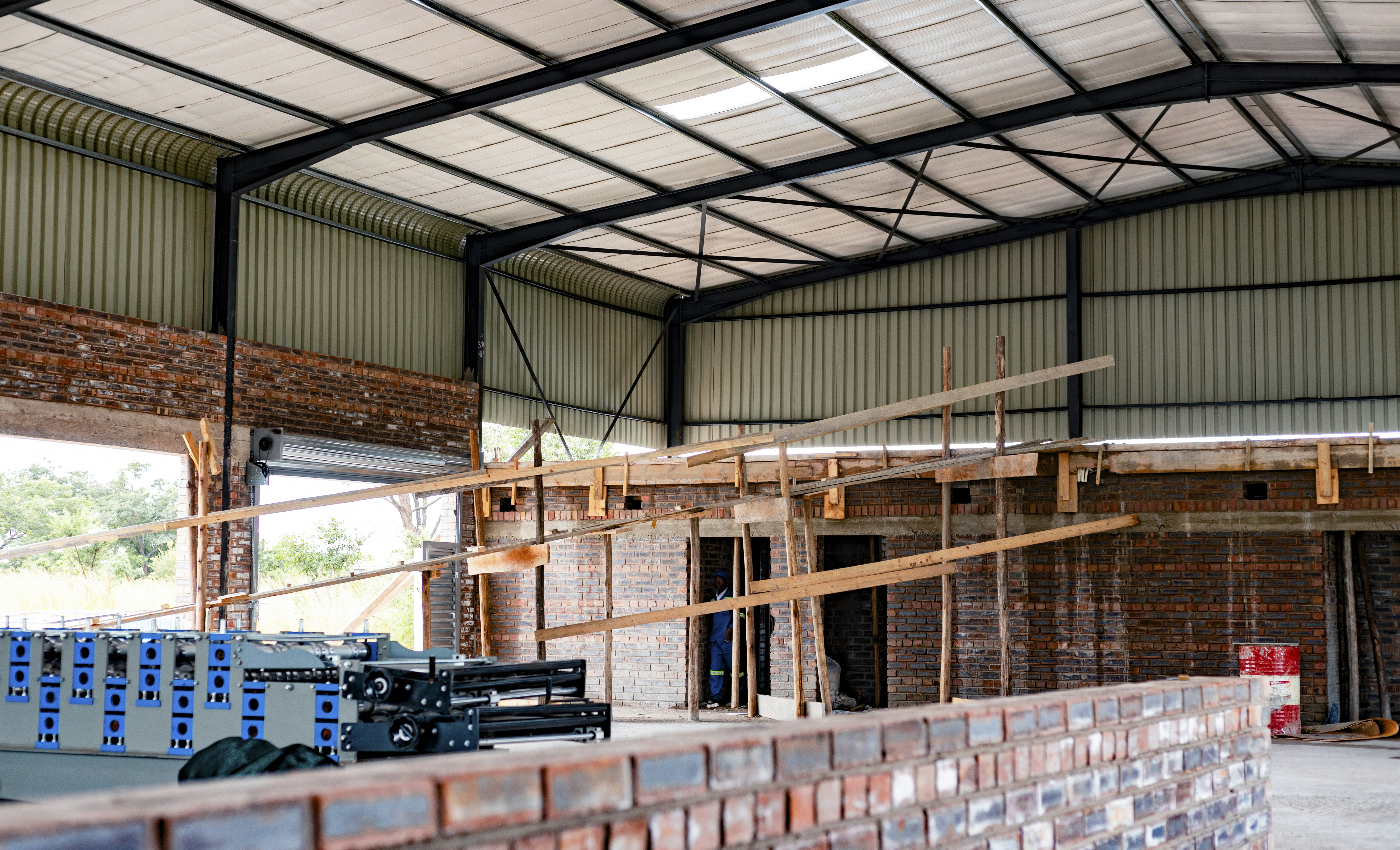 Under Construction: Wooden beams and brick walls beneath an open industrial roof