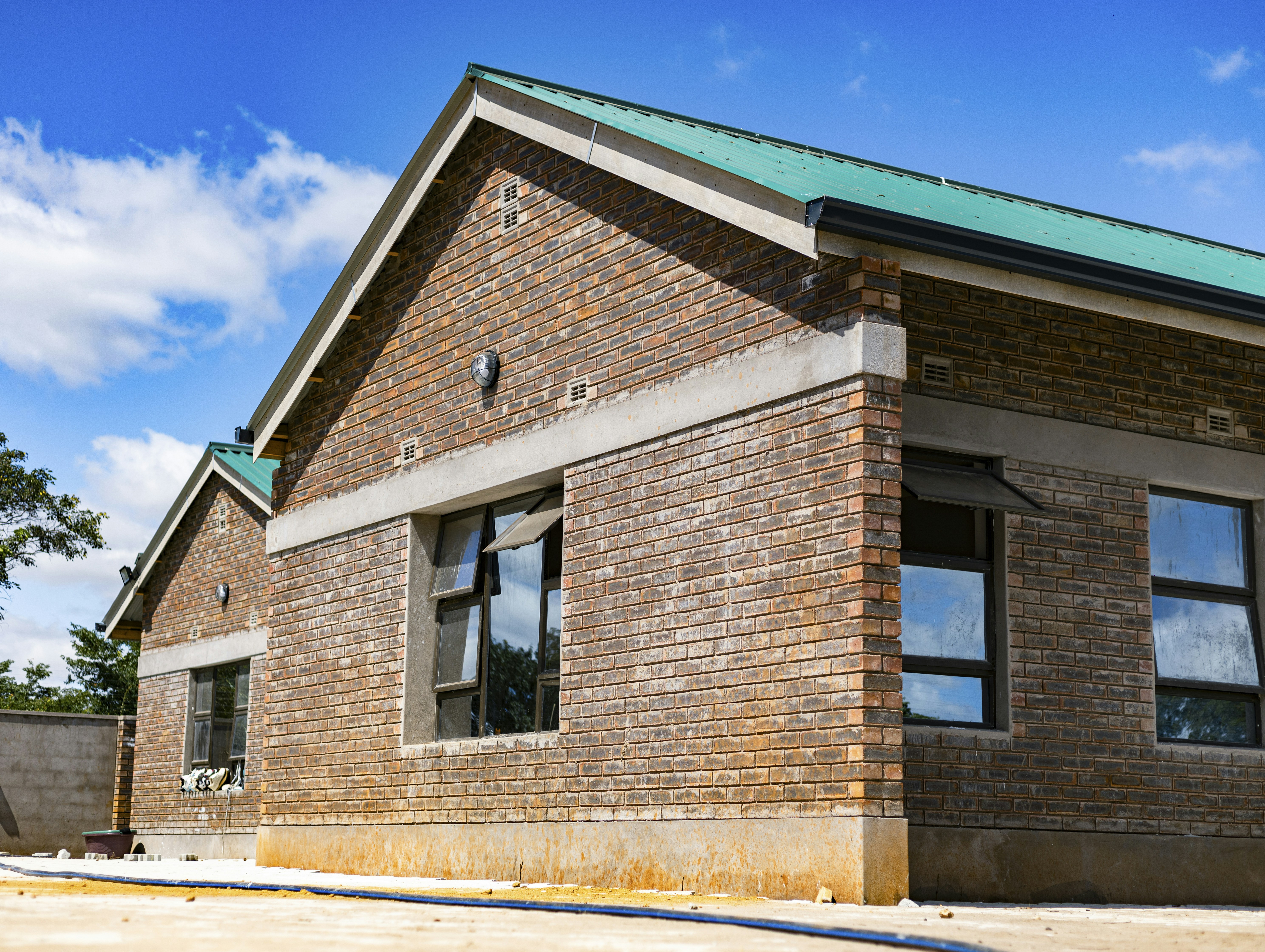 Brick Schoolhouse Under a Bright Sky
