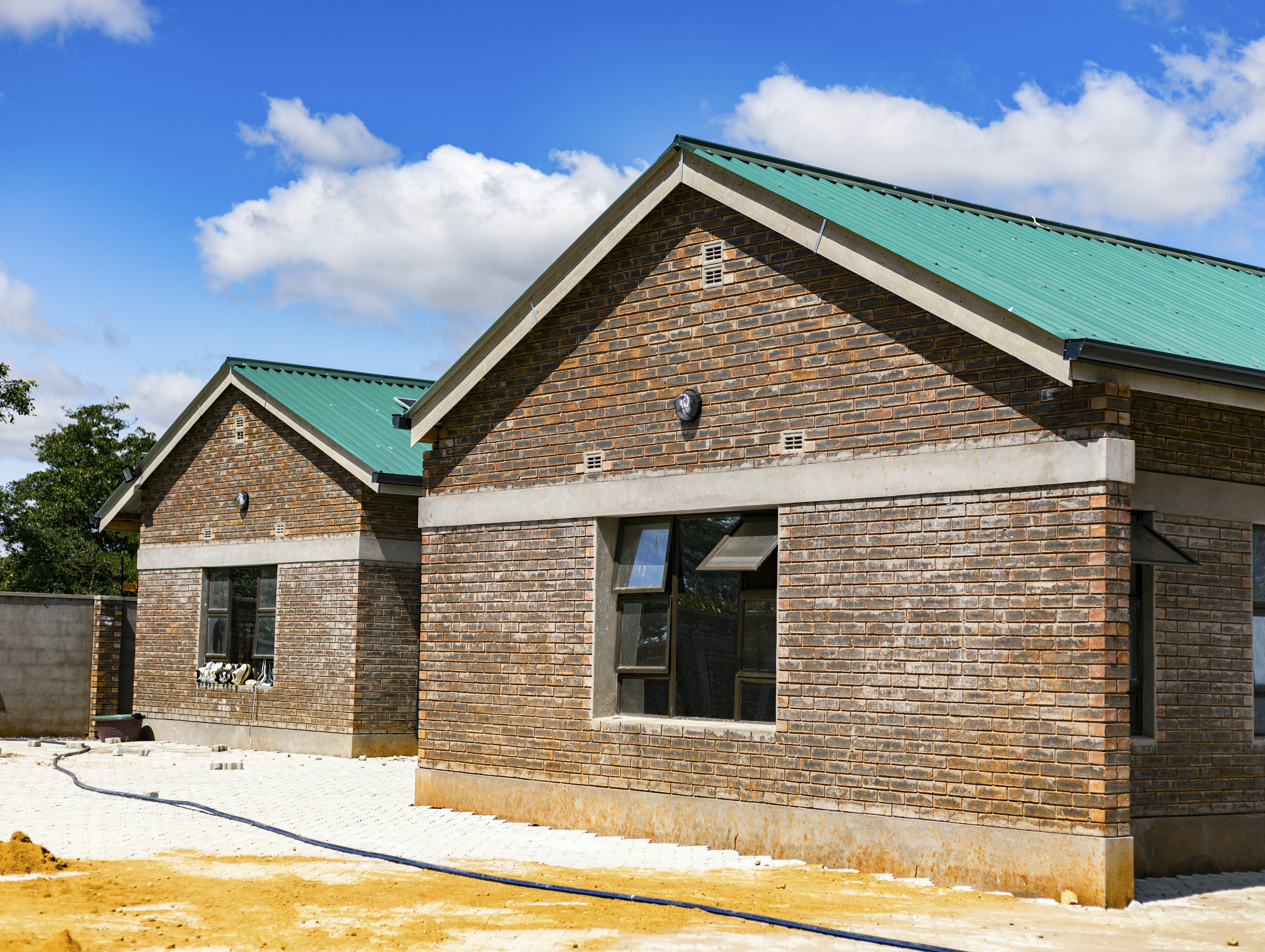 Brick House Trimmed in Sunlight: A Quiet Construction at Noon