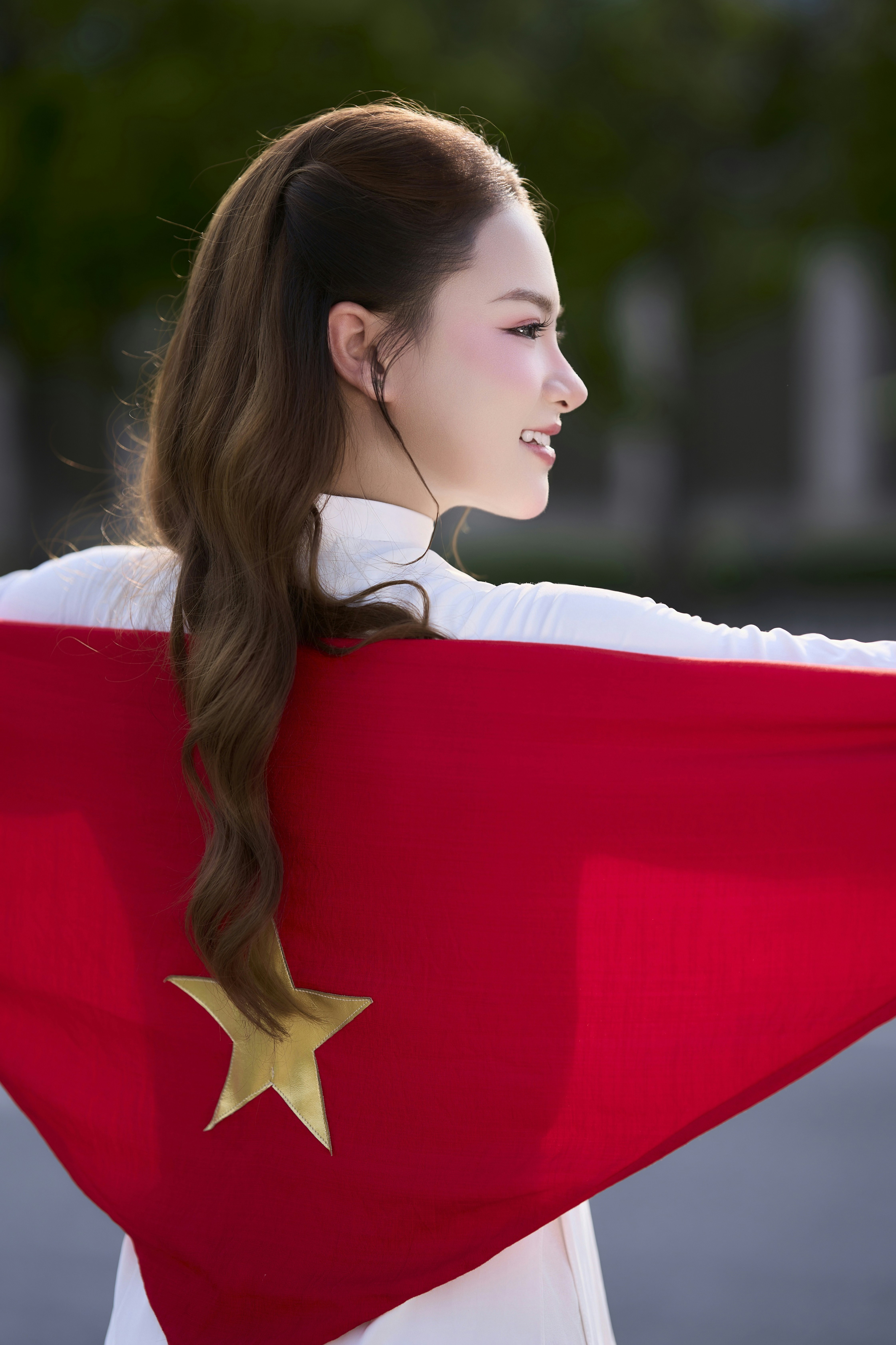 Profile in Scarlet: Pride Unfurled Across a Red Banner