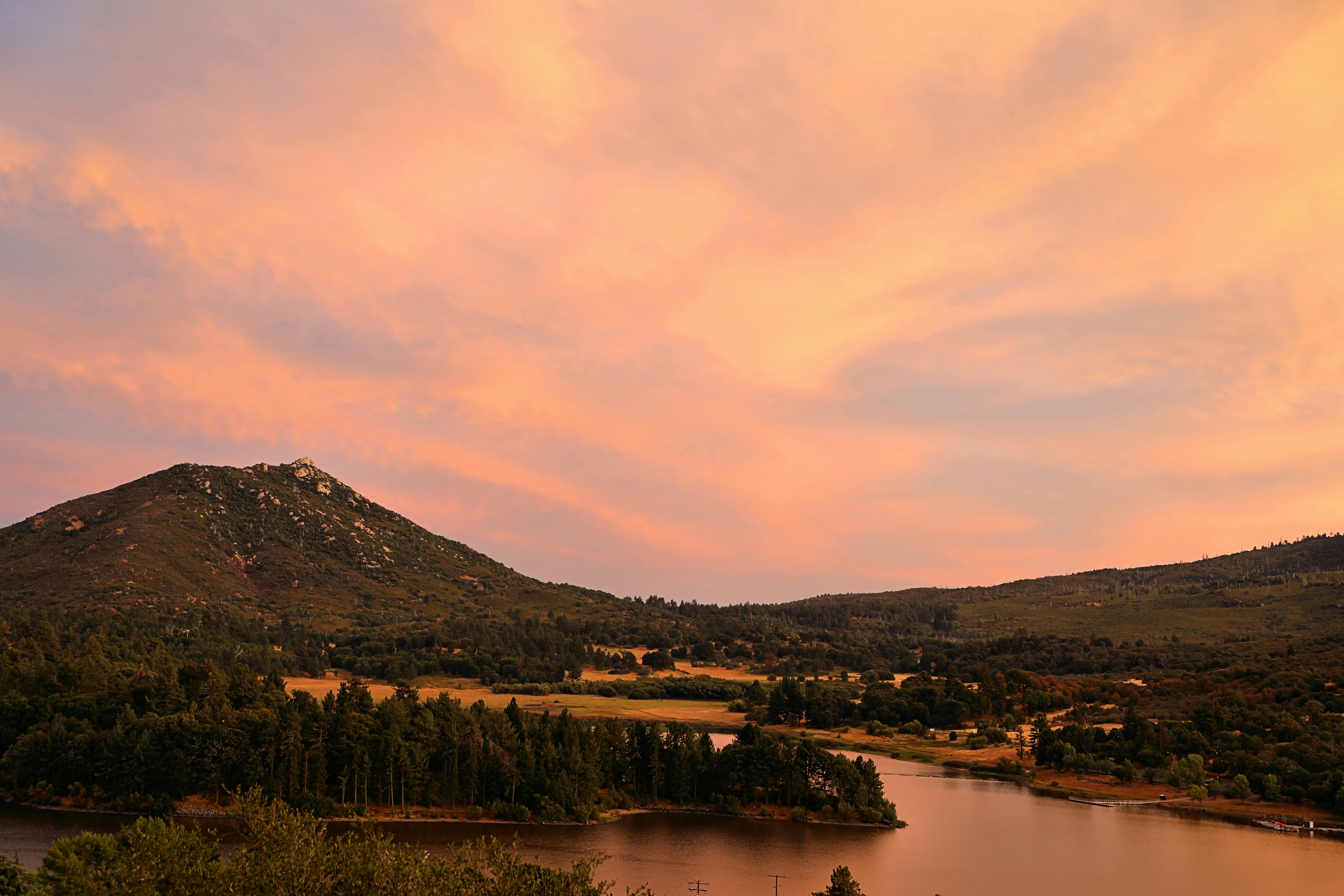 Rosy Horizon over a Quiet Pyrenees-like Lake Village