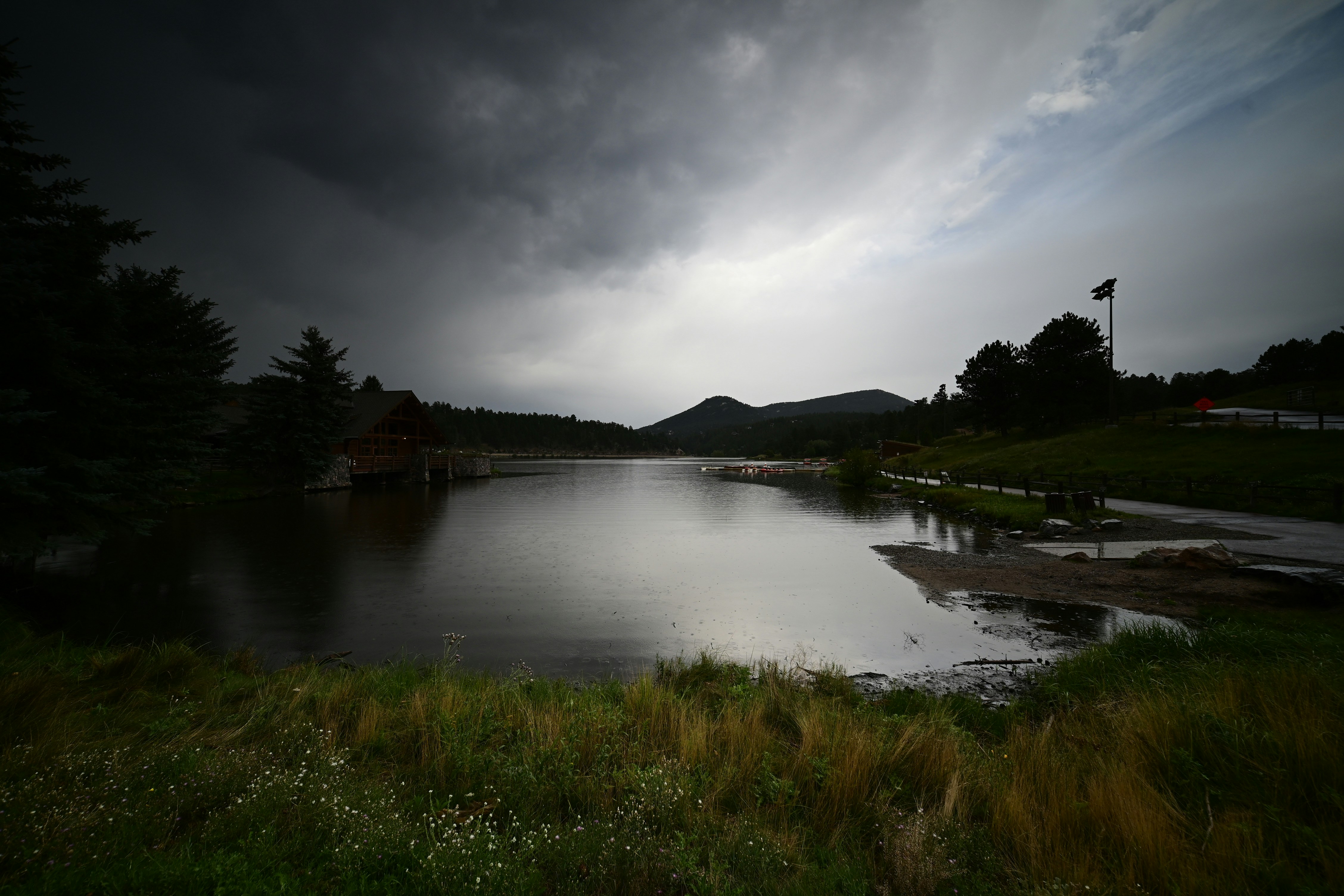 Storm Over Stillwater Pond: A Quiet Shore Under Darkening Skies