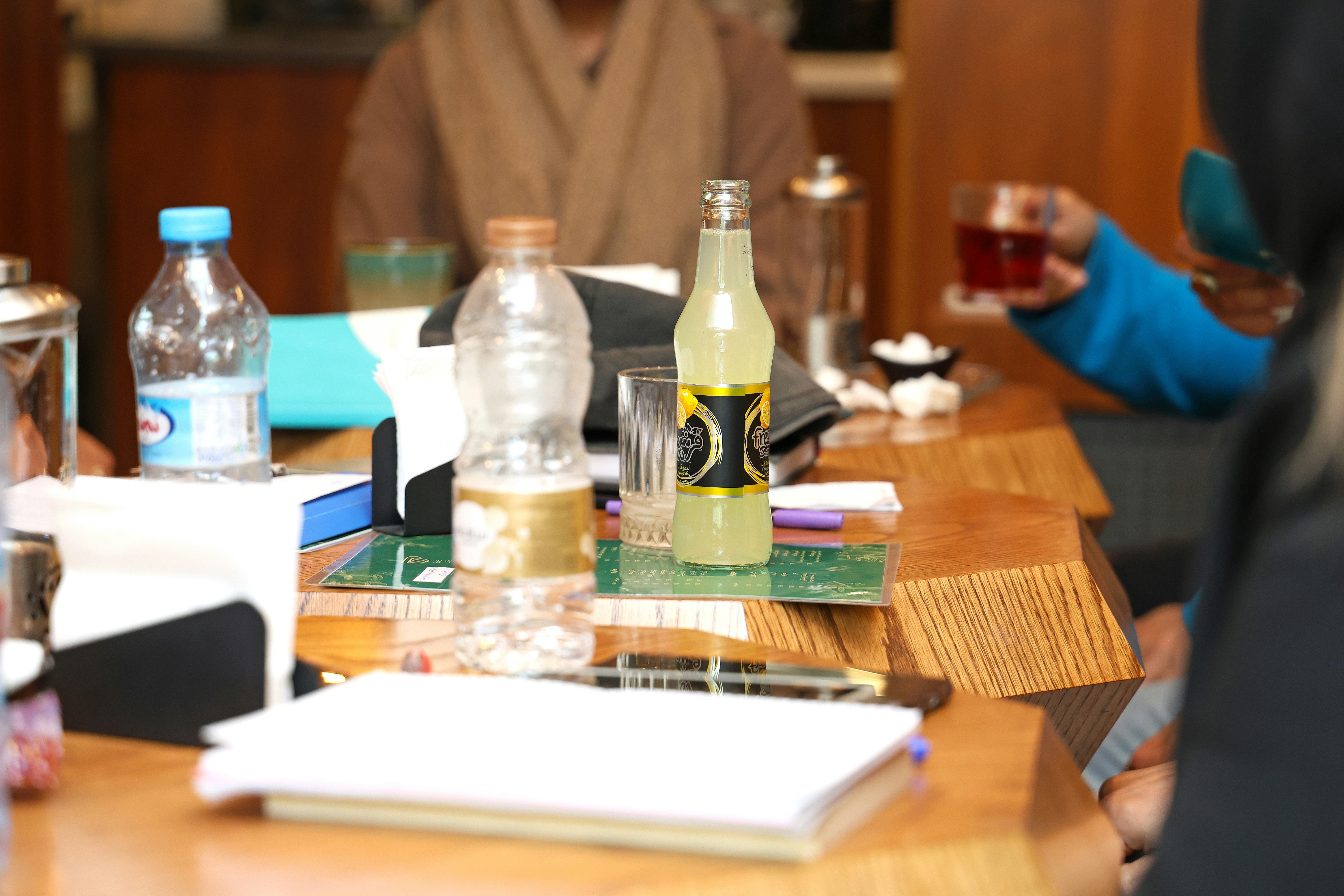 Center Bottle on the Busy Table: A Casual Gathering Moment