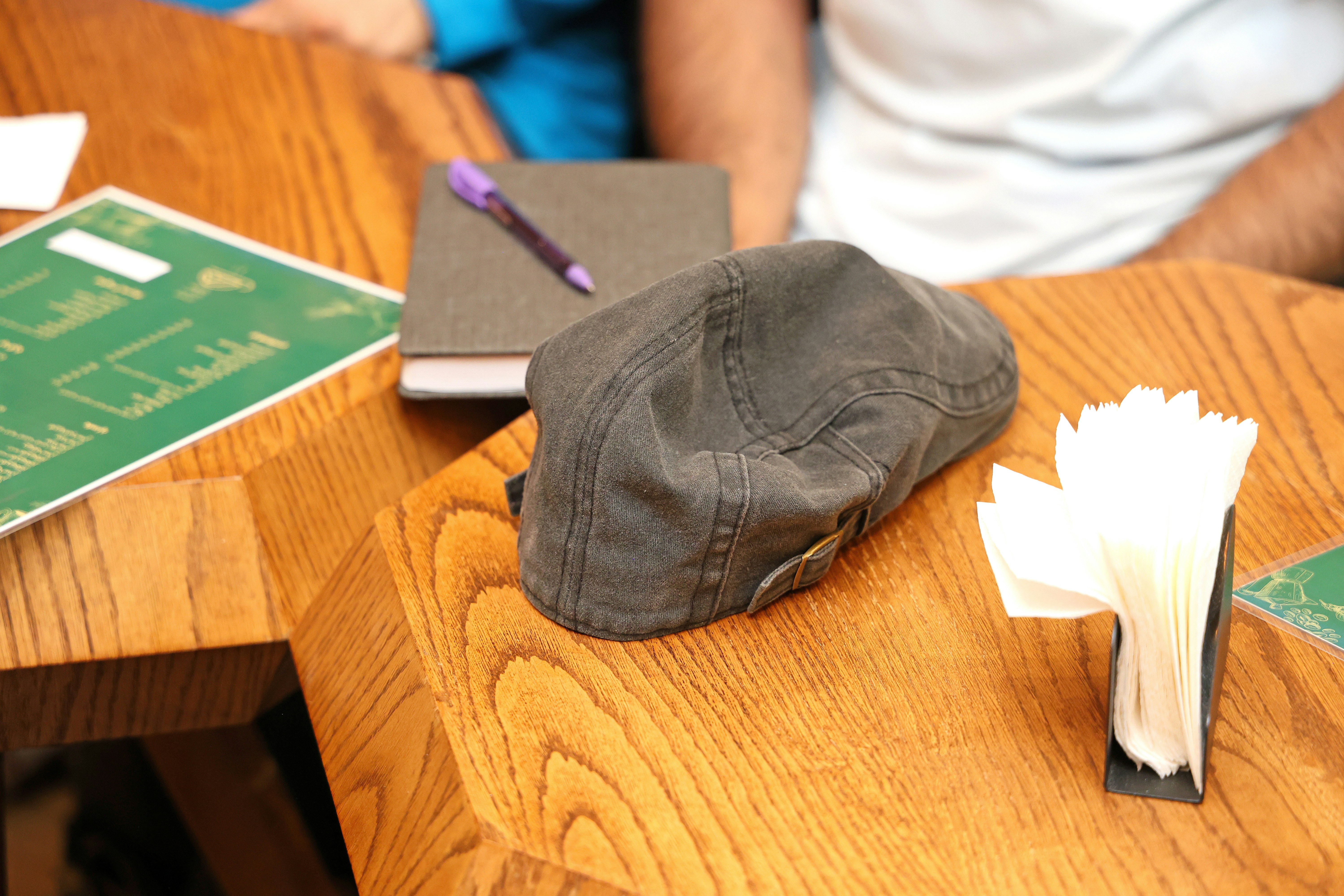 Pixelated Pause: A Casual Table Scene with a Cap and Napkin Holders