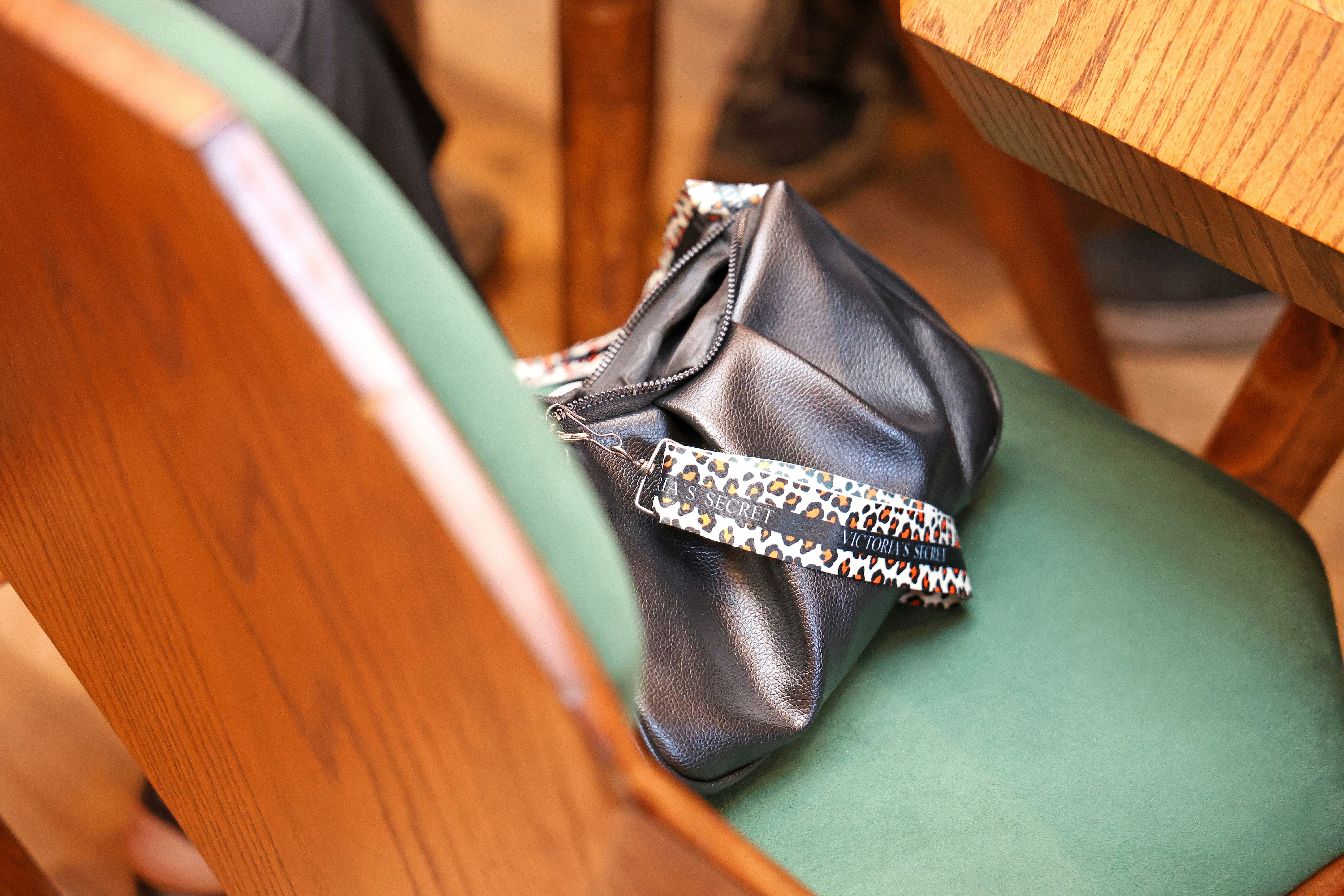 Crossroads of Style: A Studded Clutch Resting Between Wooden Chairs