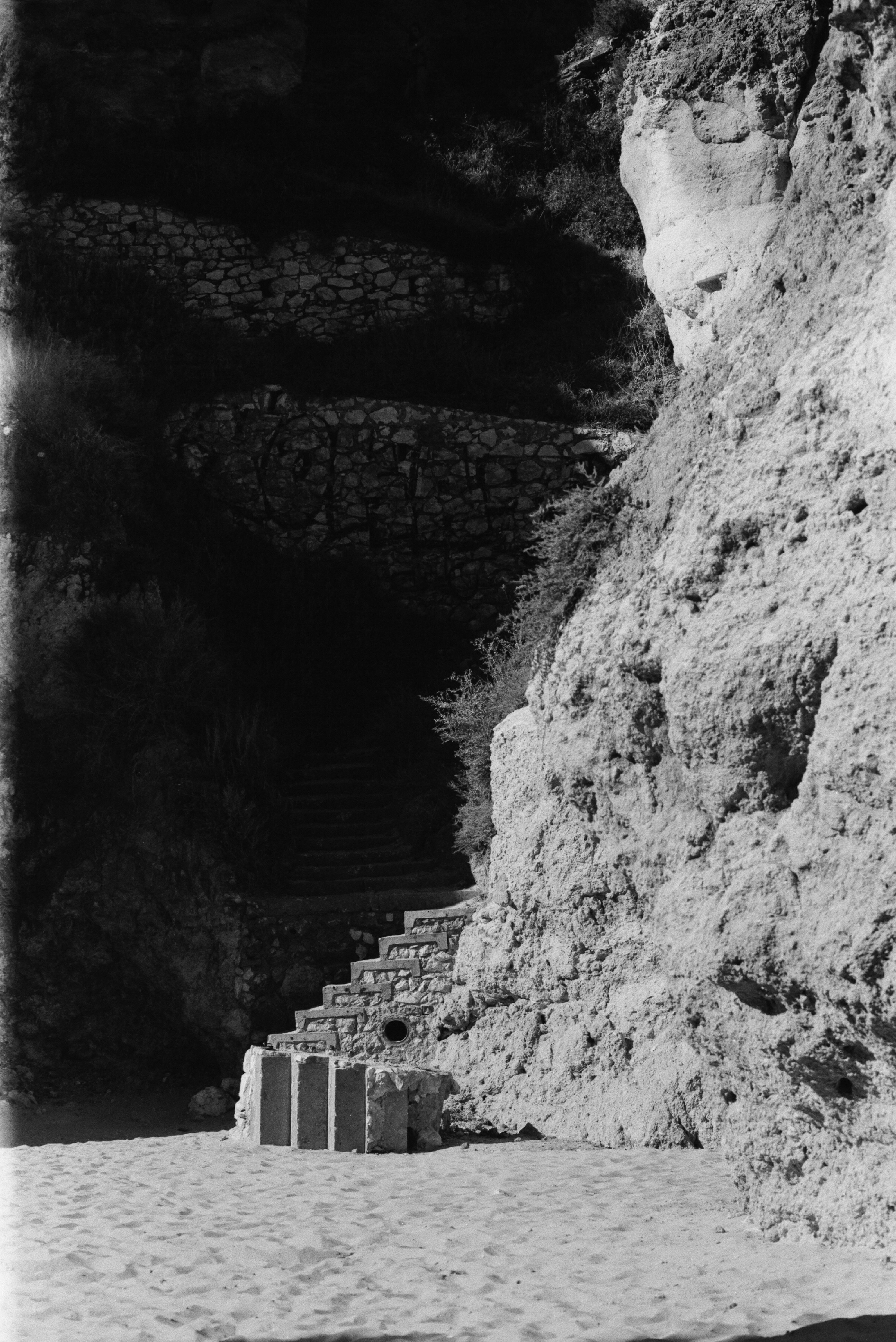 Stone Stairway Into Shadowed Cliffside