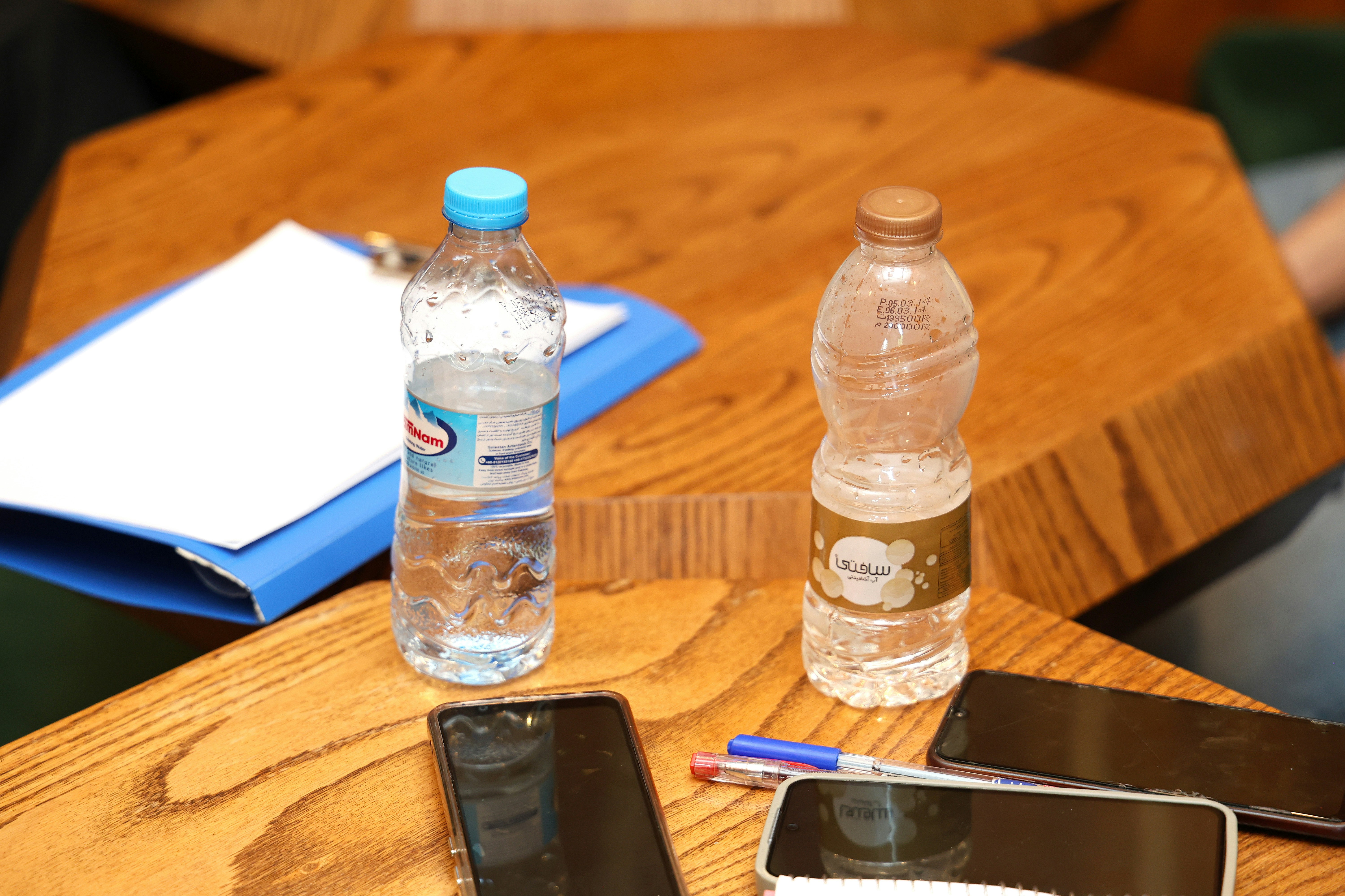 Hydration and Gadgets on a Wooden Table