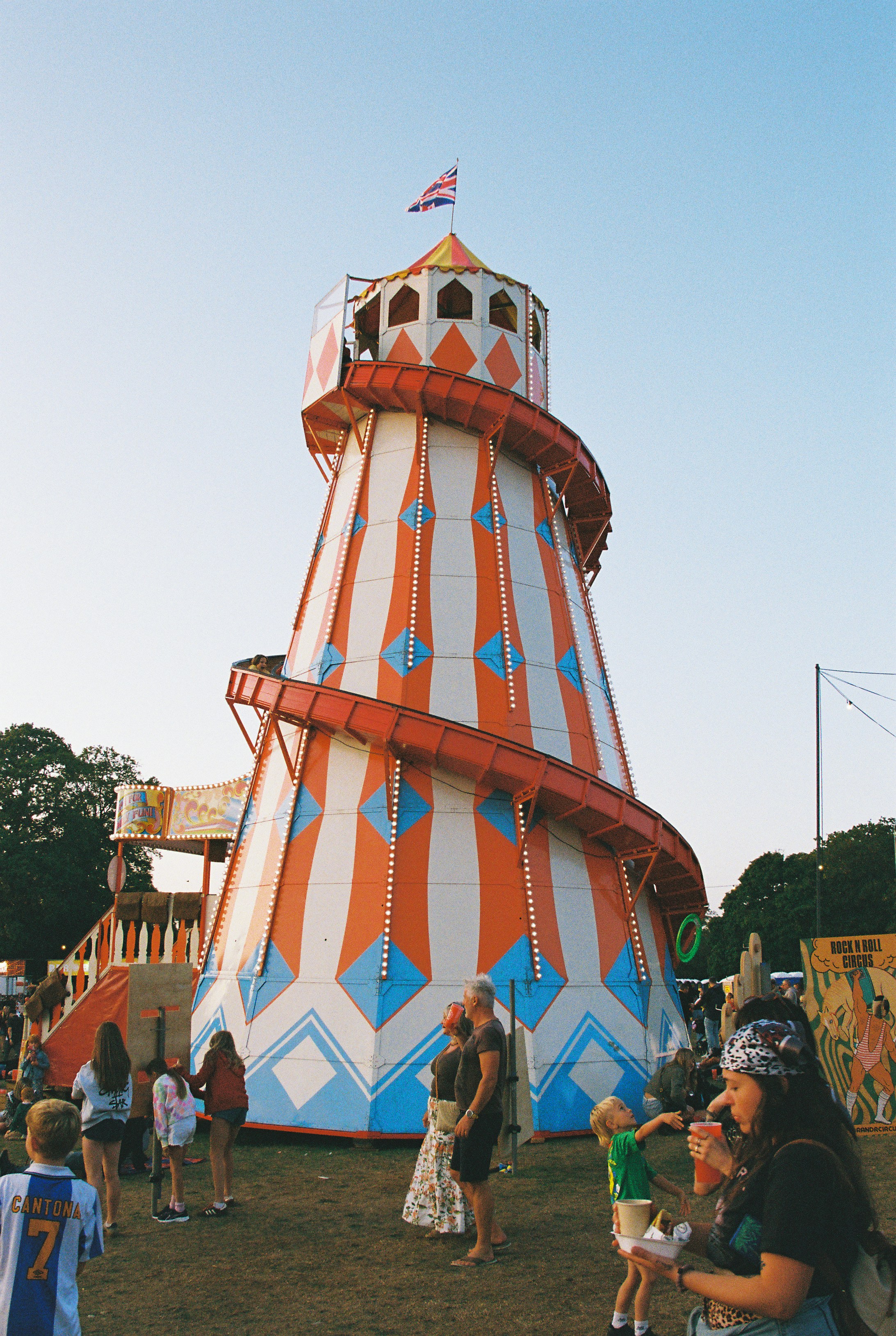 Candy-striped lighthouse at a lively fairground