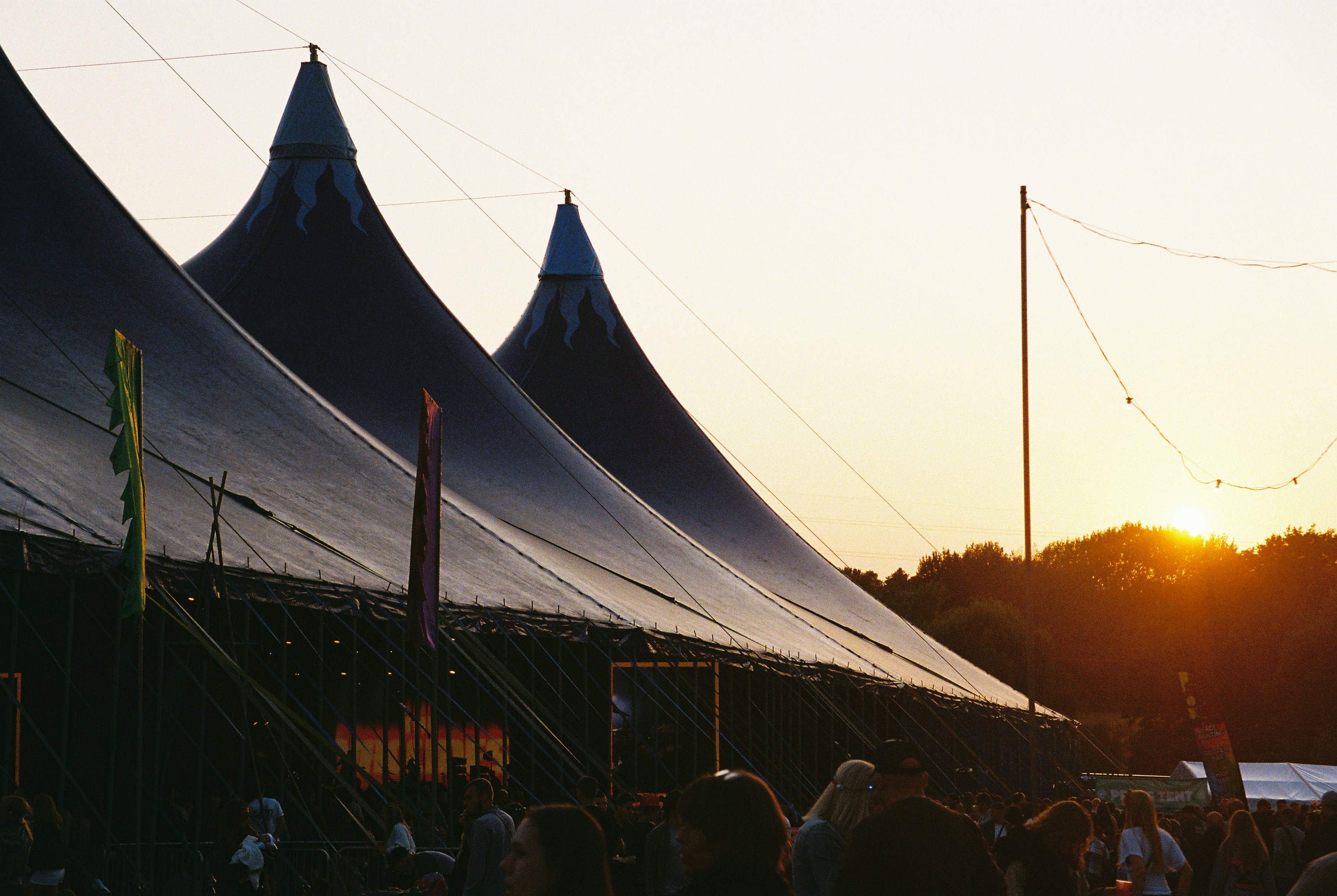 Sunset Beneath the Canopy: Festival Sky and Silhouettes