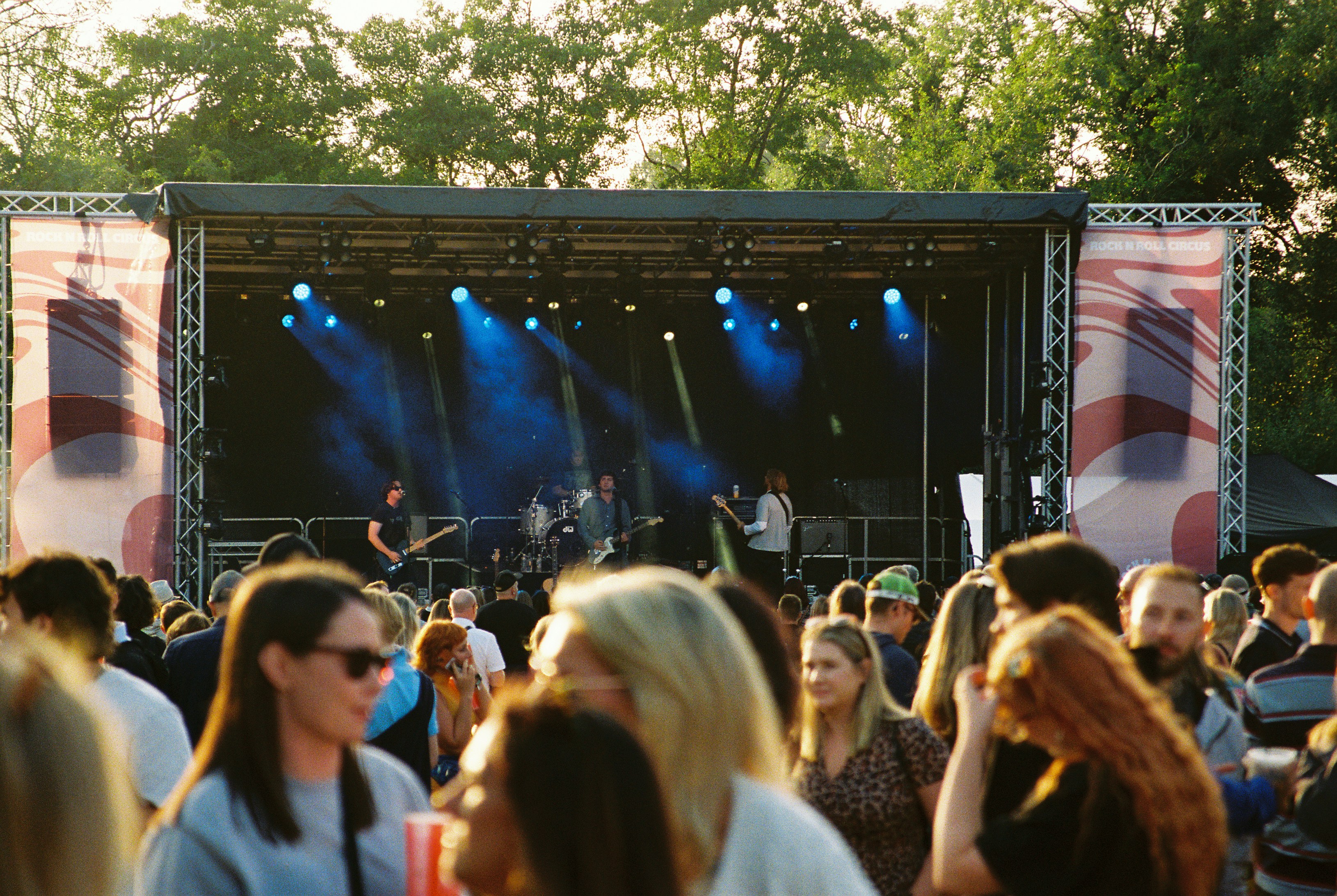 Midfield Pulse: Crowd Faces and Stage Lights at Sunset Concert