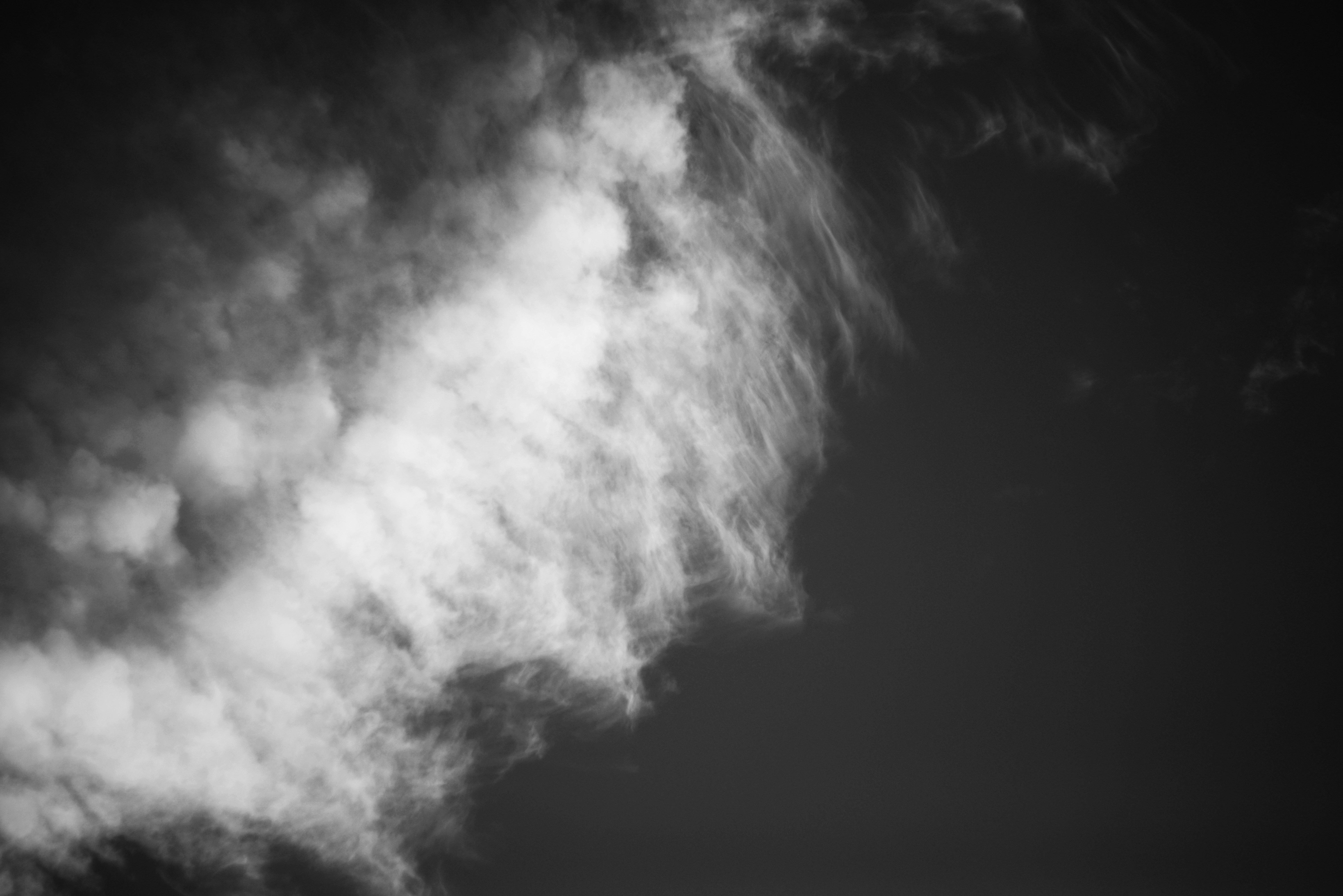 Fragmented Sky: A Cloud Fracture against Clean Black