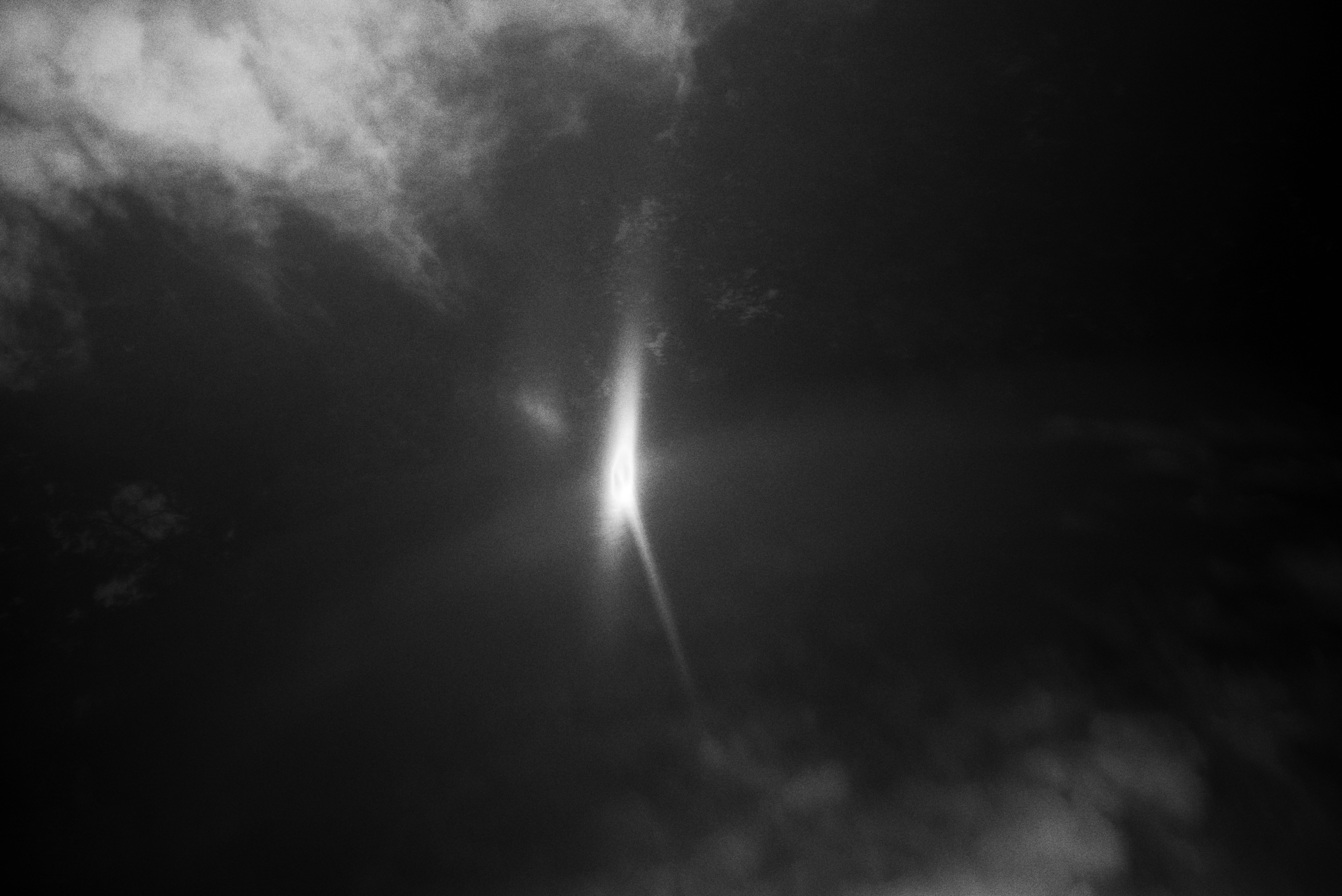 Midnight Jet: a solitary rocket slash across a cloudy sky
