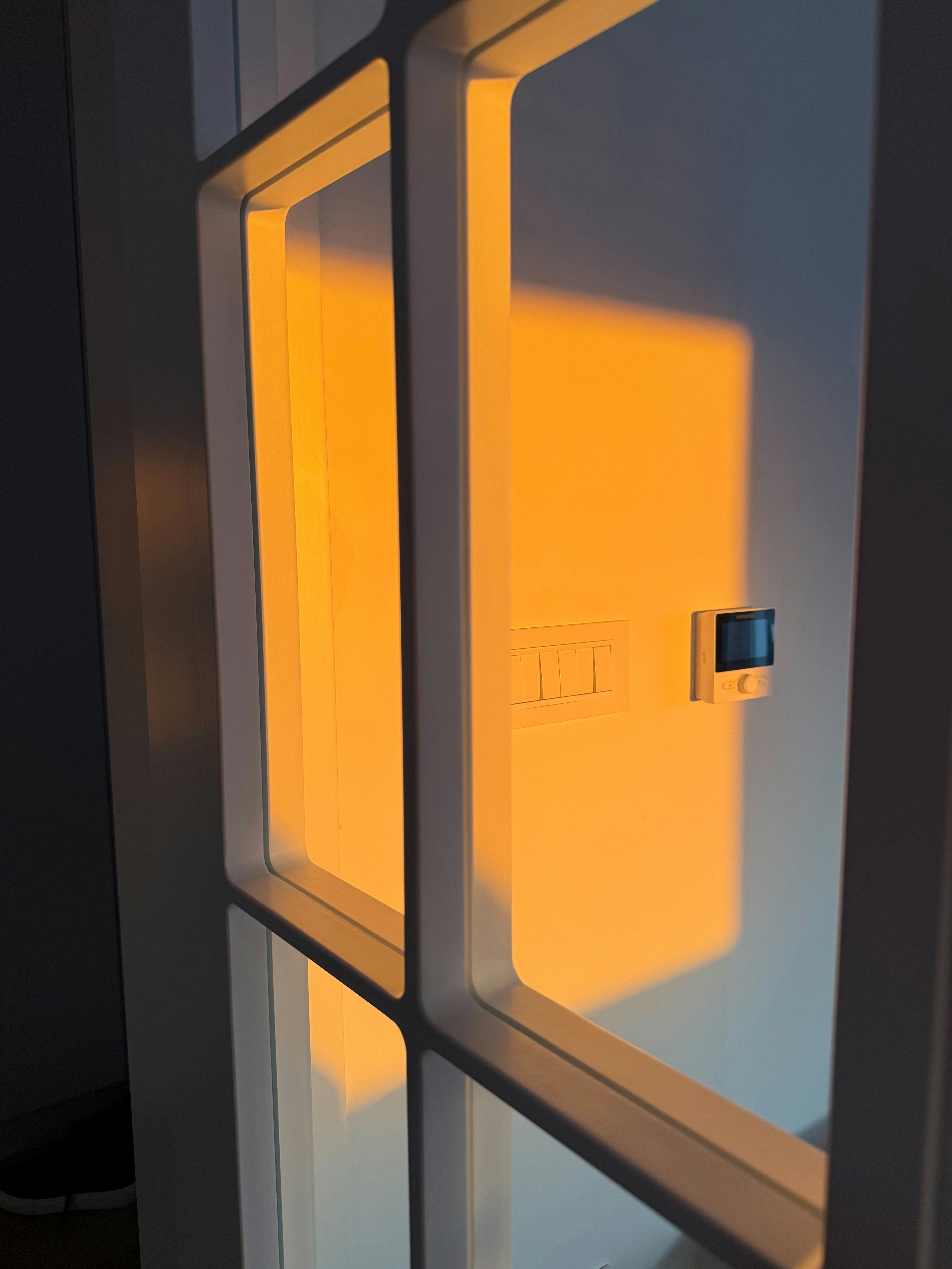 Golden Hour Reflections on a Modern Door Frame
