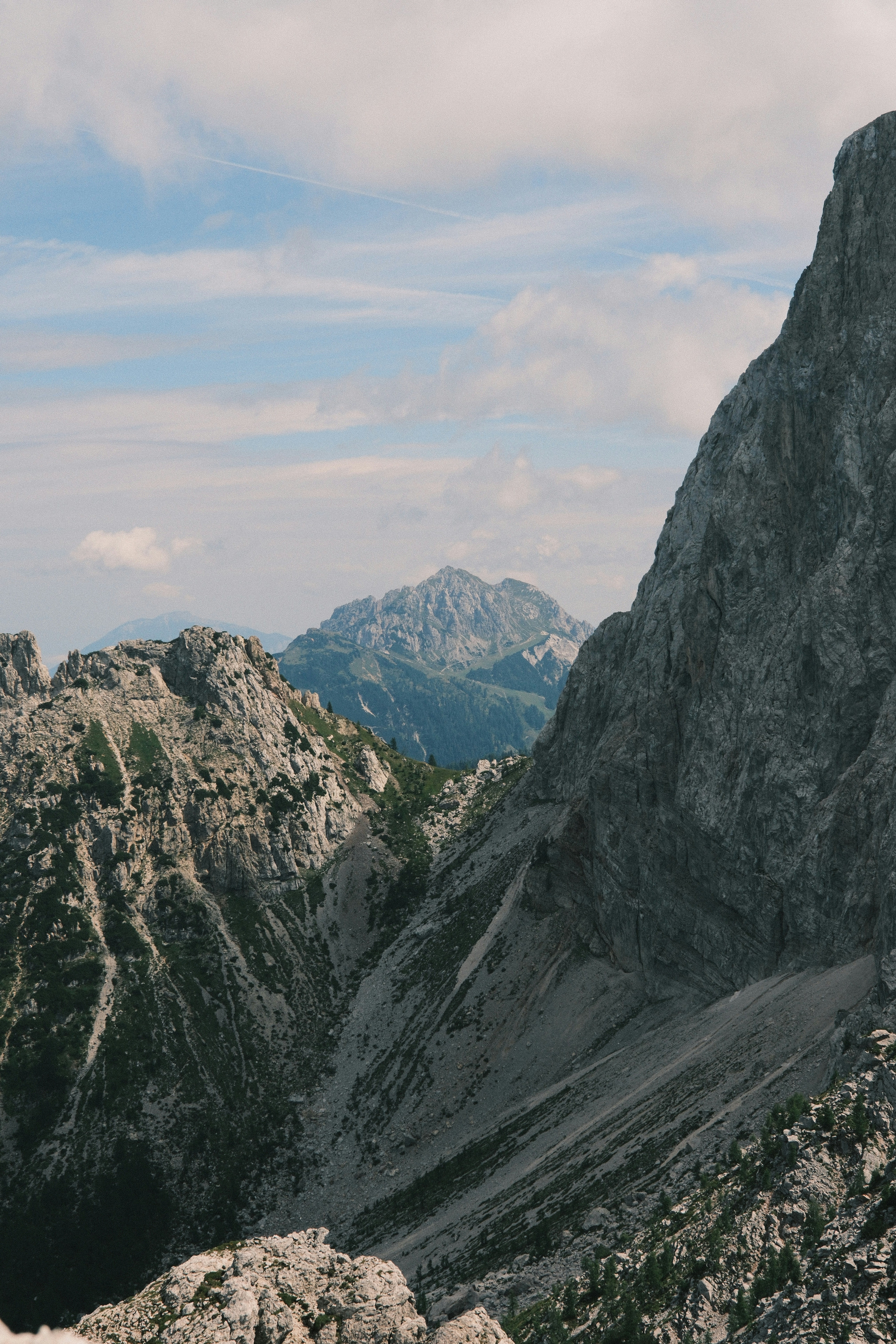 Between jagged basalt and distant peaks: a mountain valley underscored by towering stone