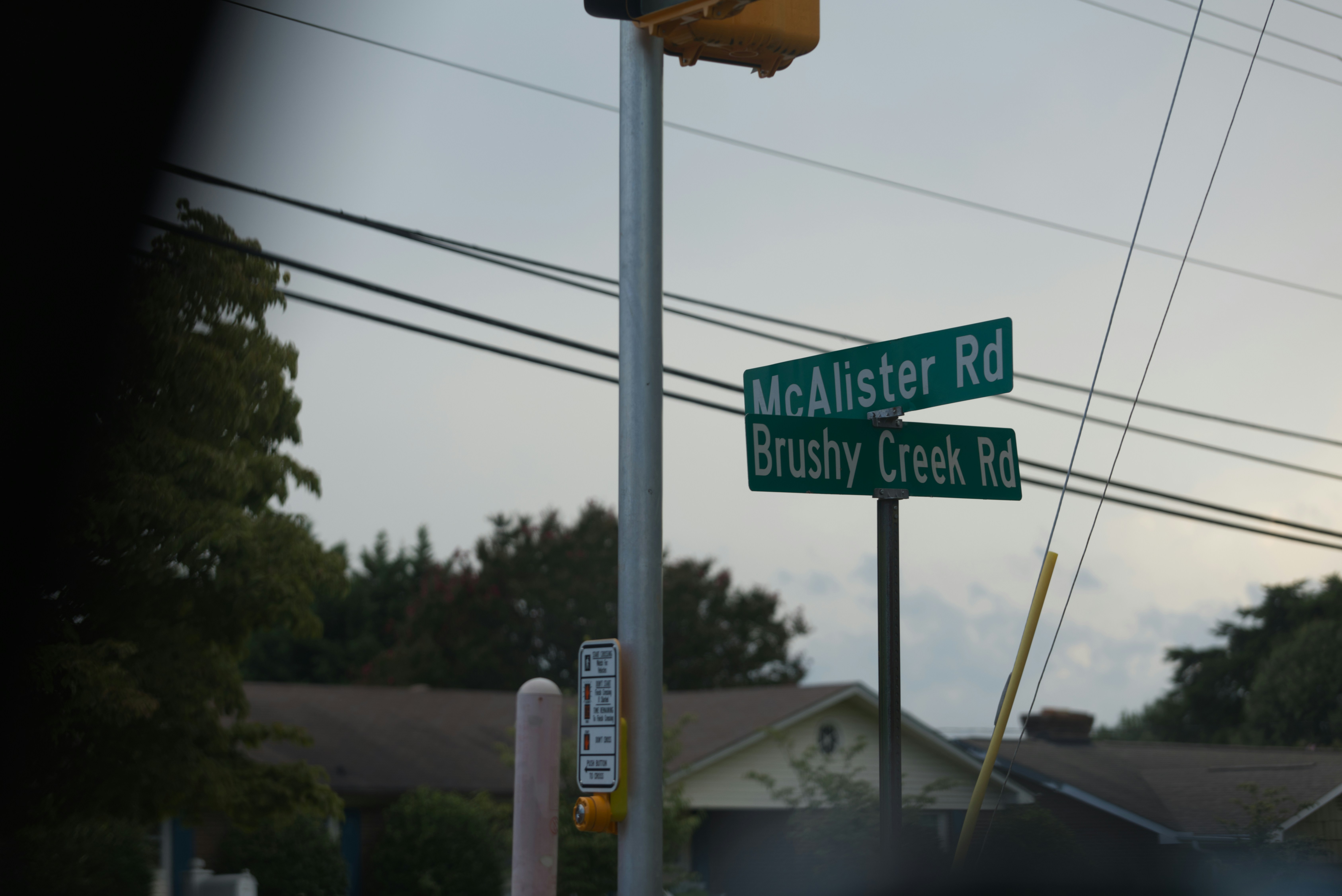 Intersection Signpost Under Wire-Lined Sky