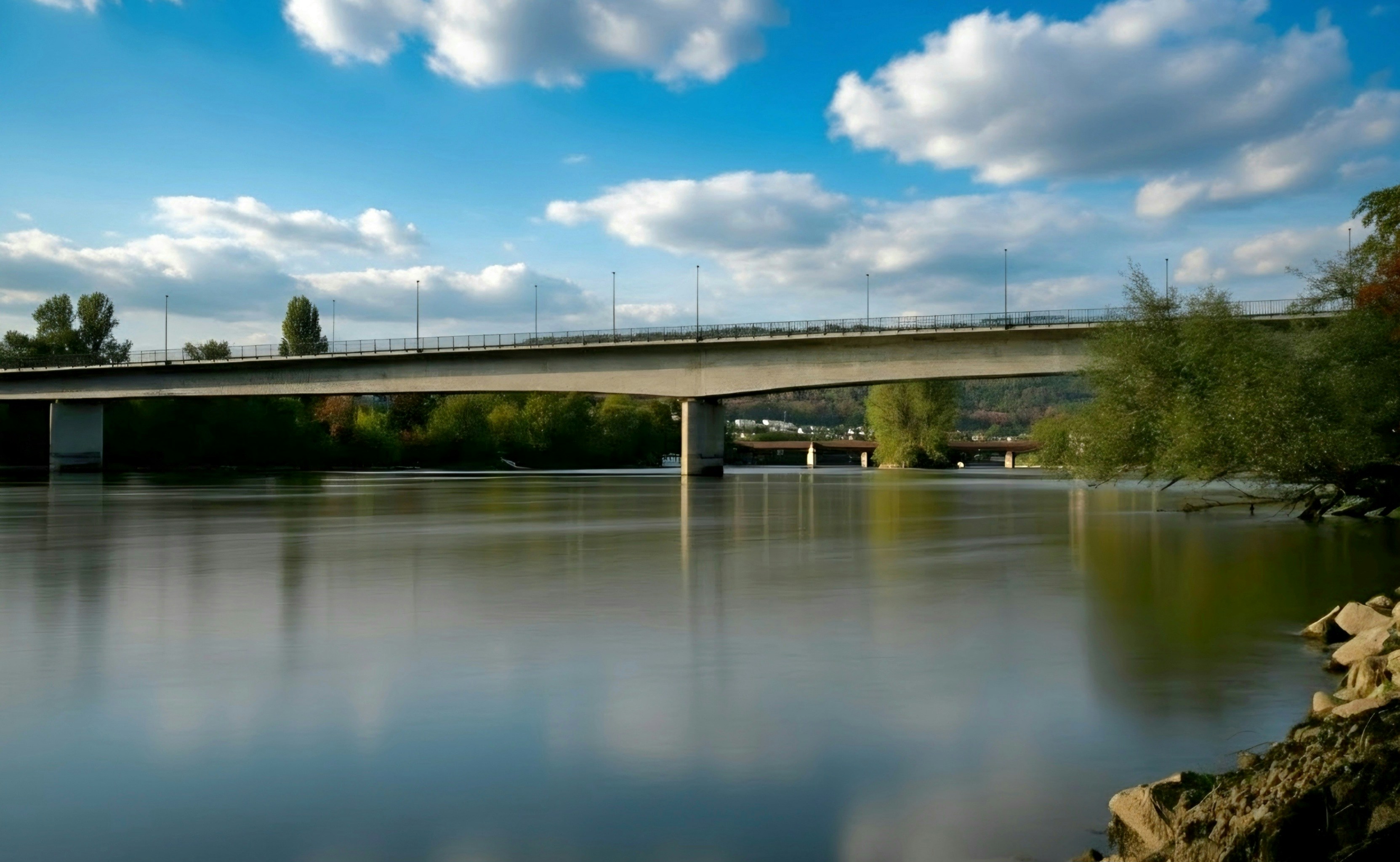 Bridge over a Quiet Riverside: Morning Light and Soft Reflections