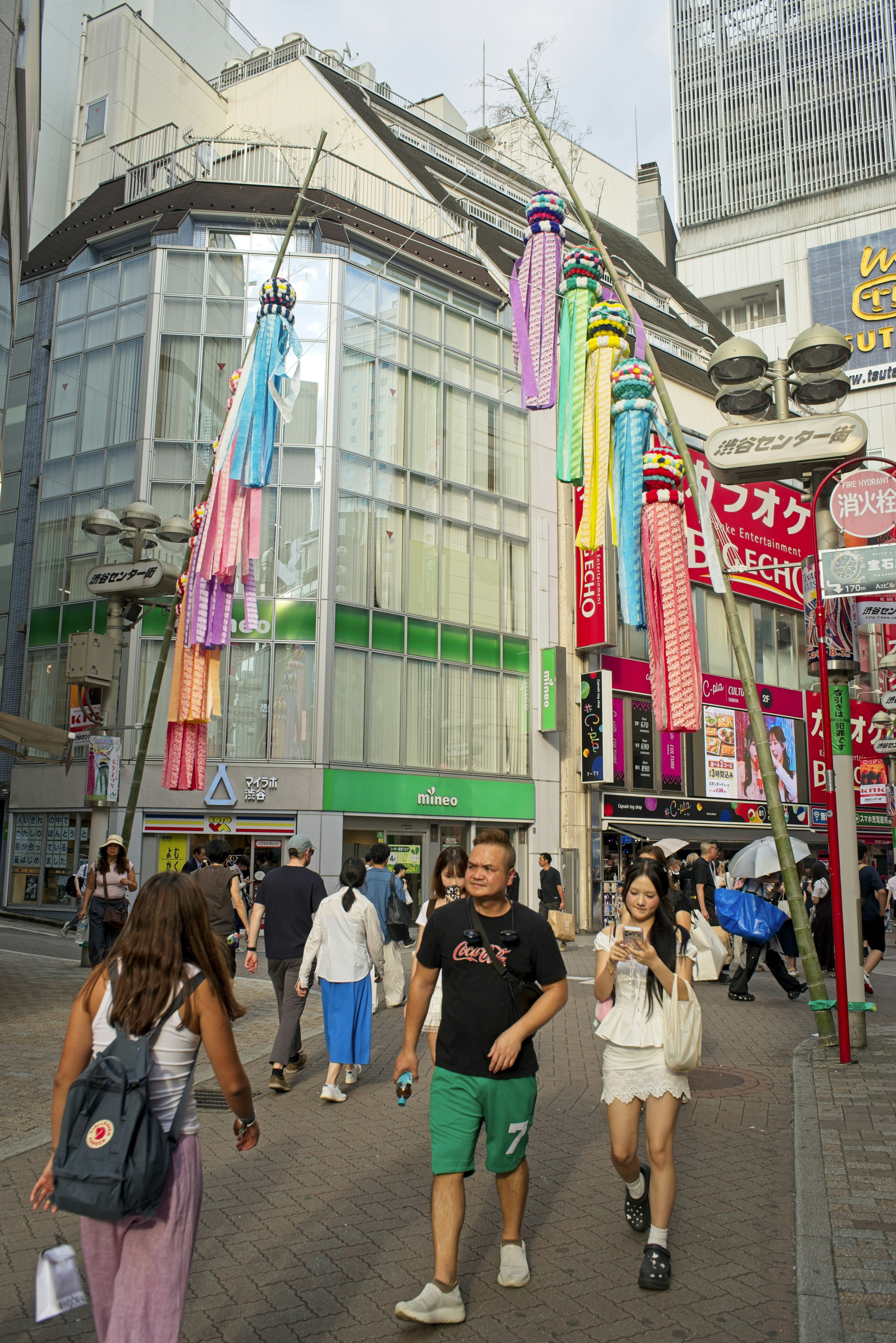 City Pulse Under Colorful Koinobori: A Busy Street Portrait
