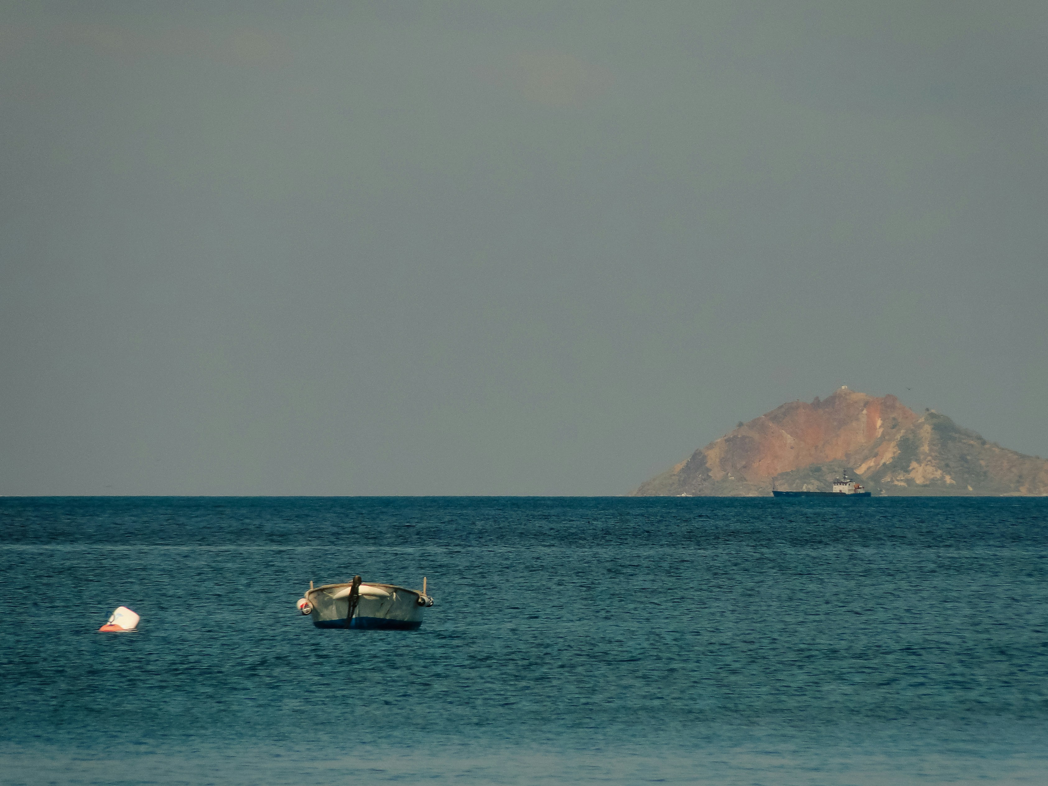 Isolated Boat at Distant Horizon