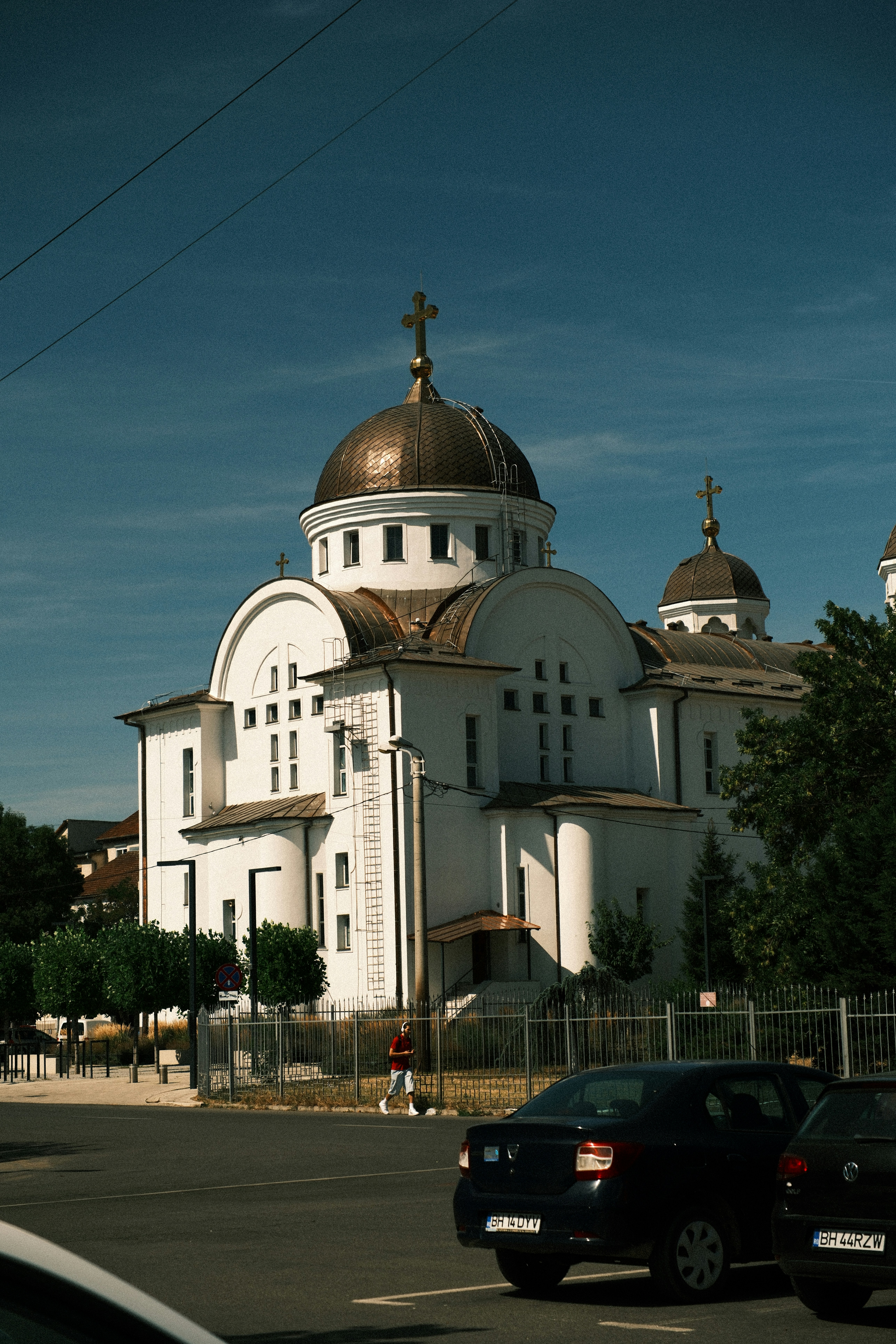 Orthodox Cathedral in Morning Light with Passing Pedestrian