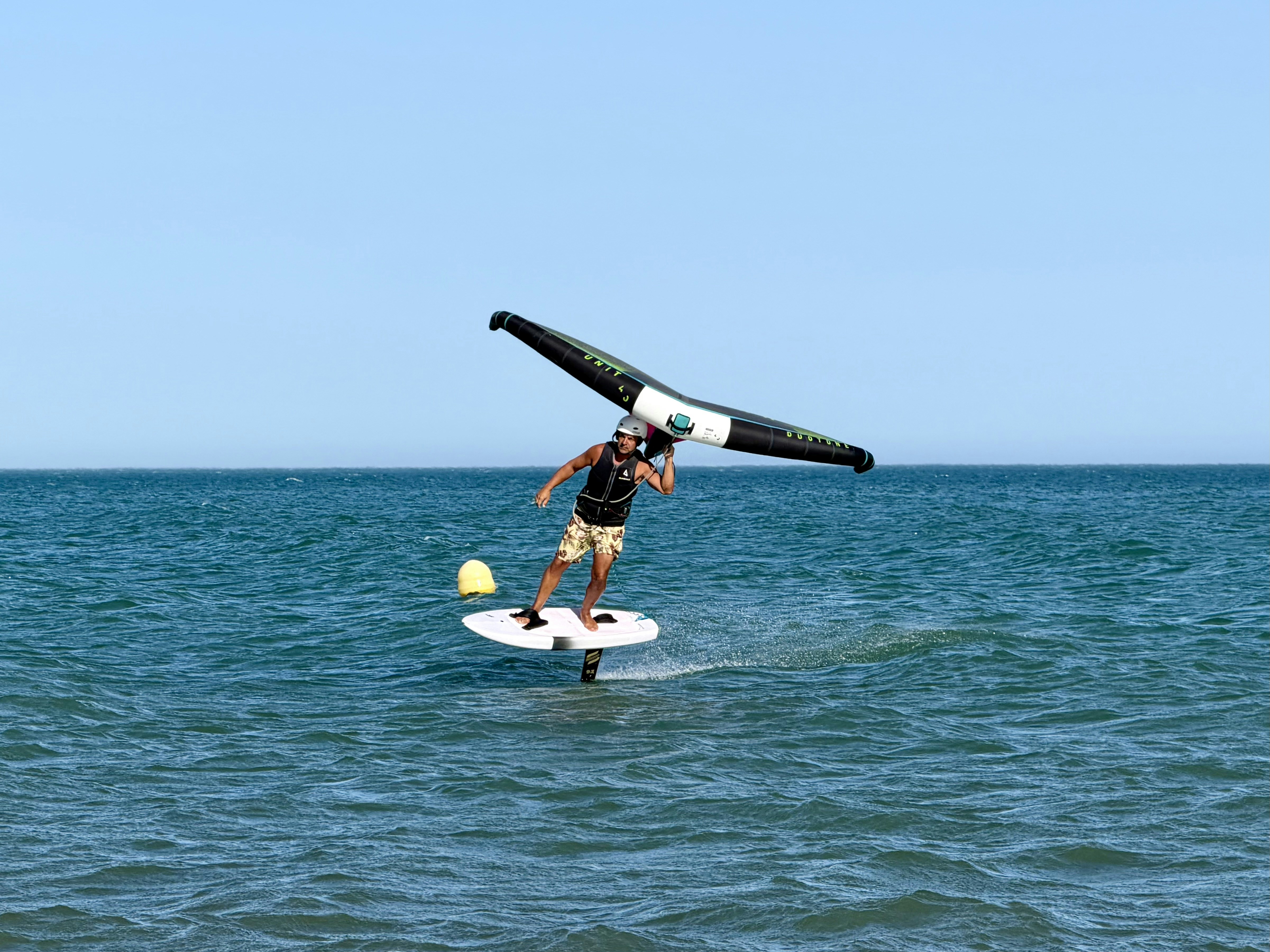 Hydrofoil Hero: Soaring Over Seafoam and Shielding the Sun