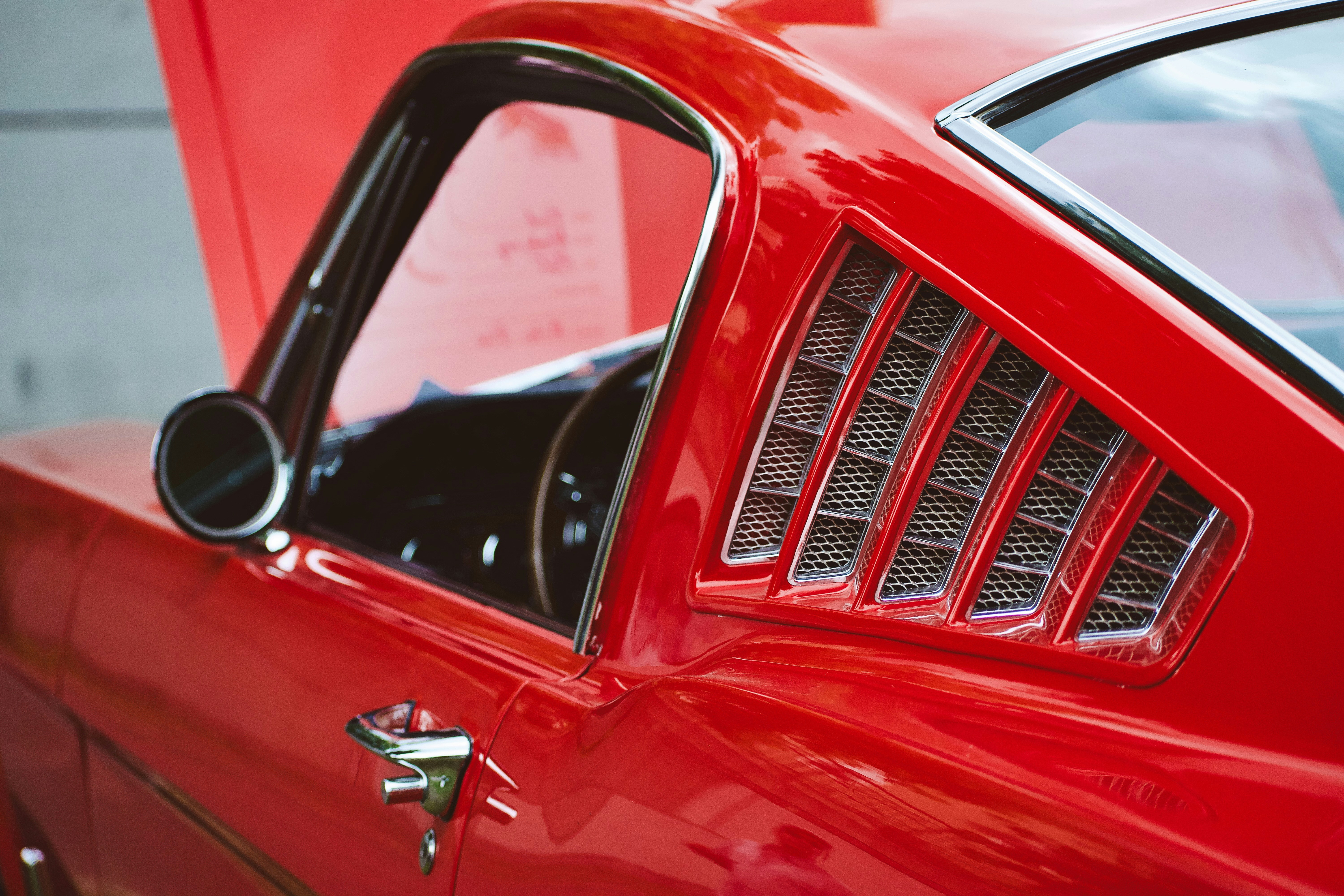 Red Vintage Car Door Vent: Chrome and Curves in Focus