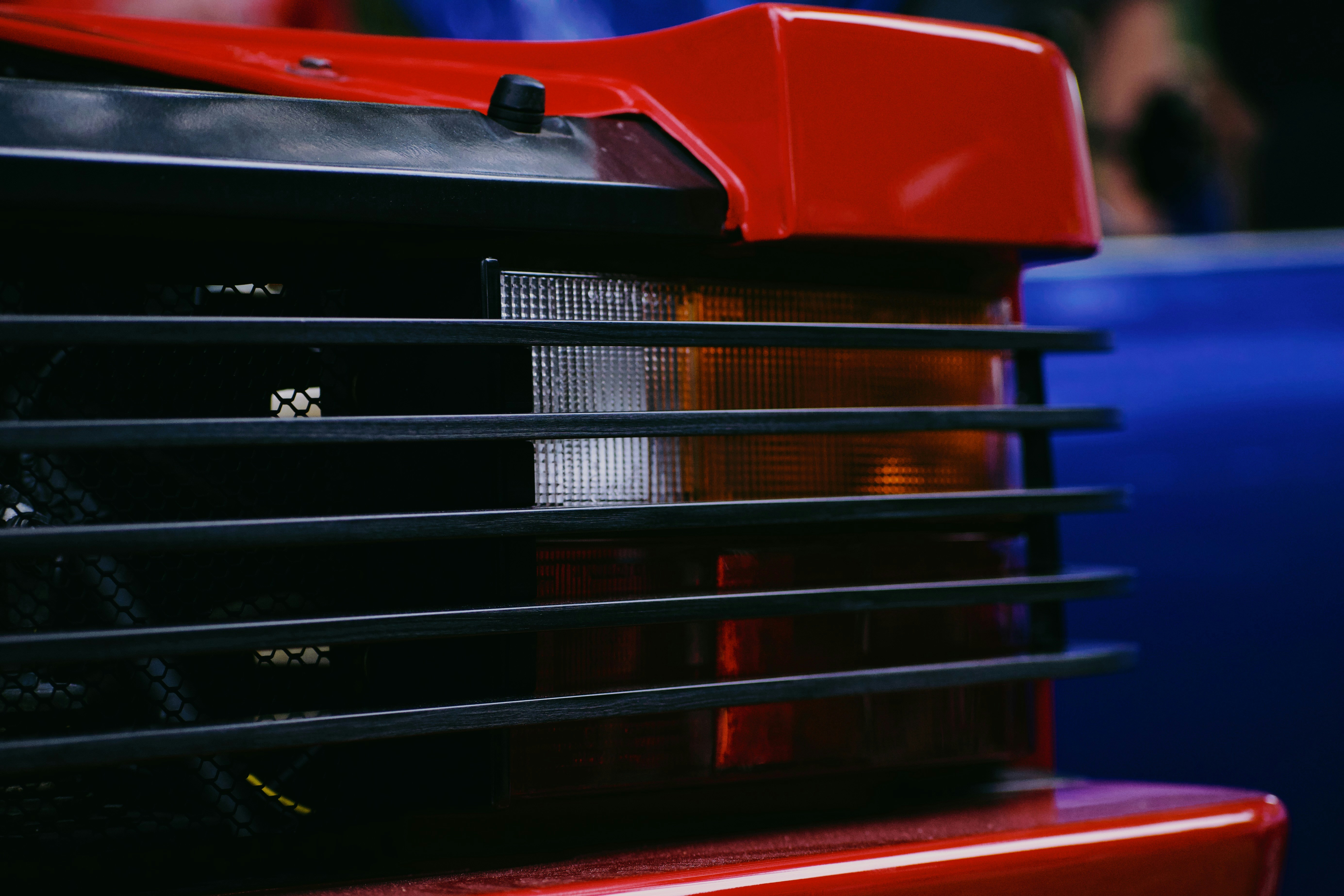 Close-up of a Red Car Front Grille and Headlight